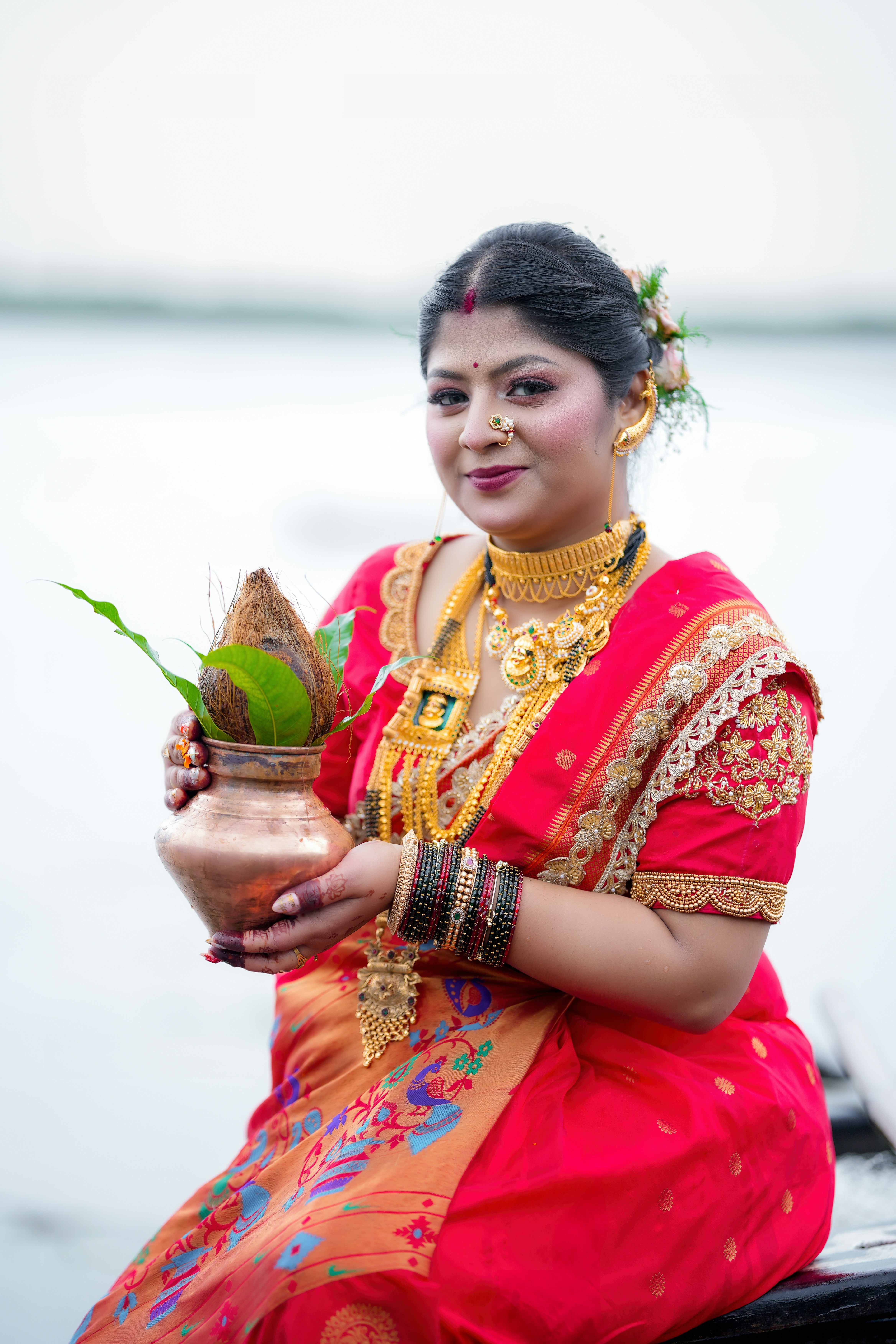 Grace in Red: A Traditional Moment by the River