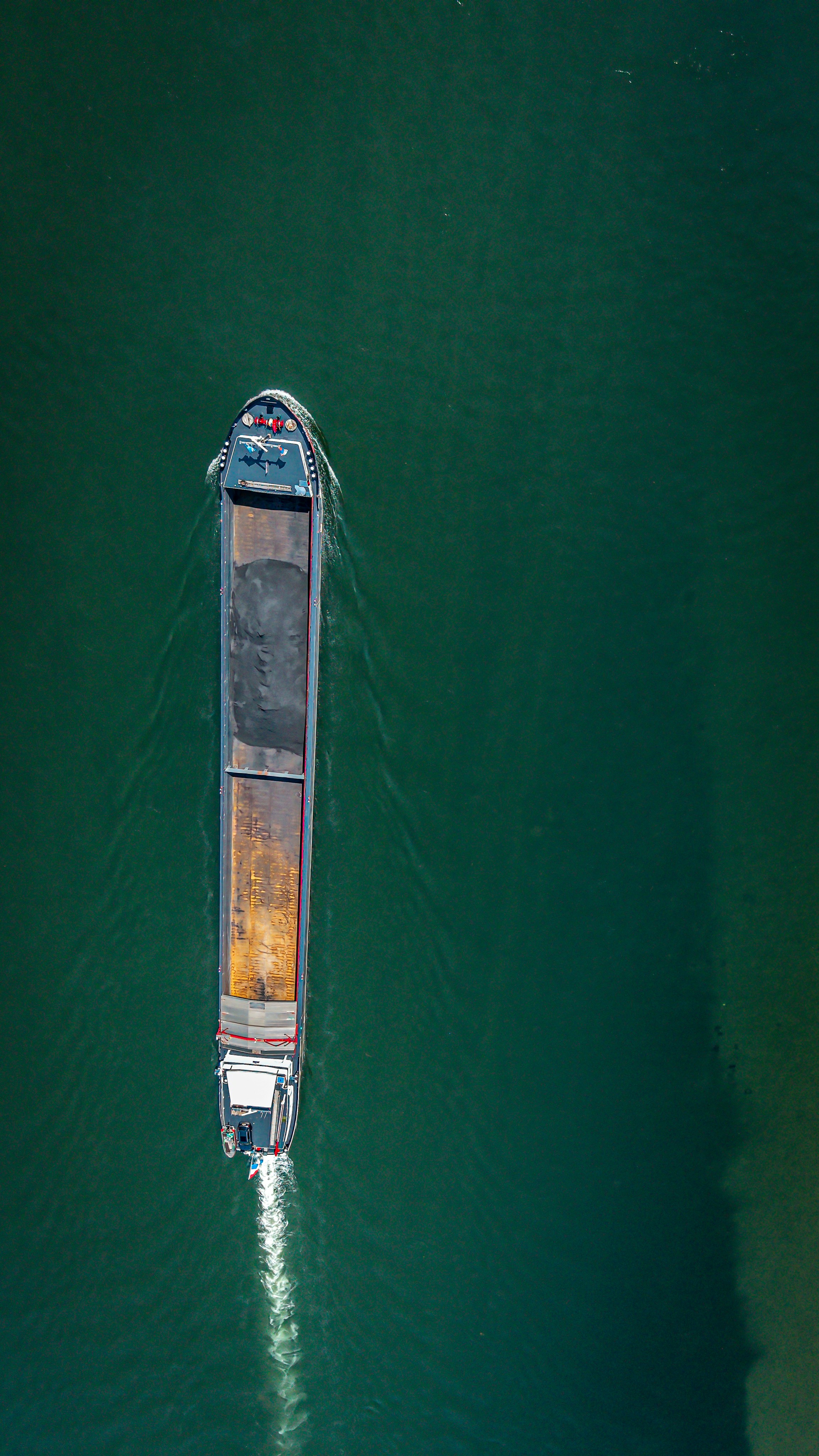 Aerial Post in the Deep: Freight Vessel Skimming Turquoise Waters