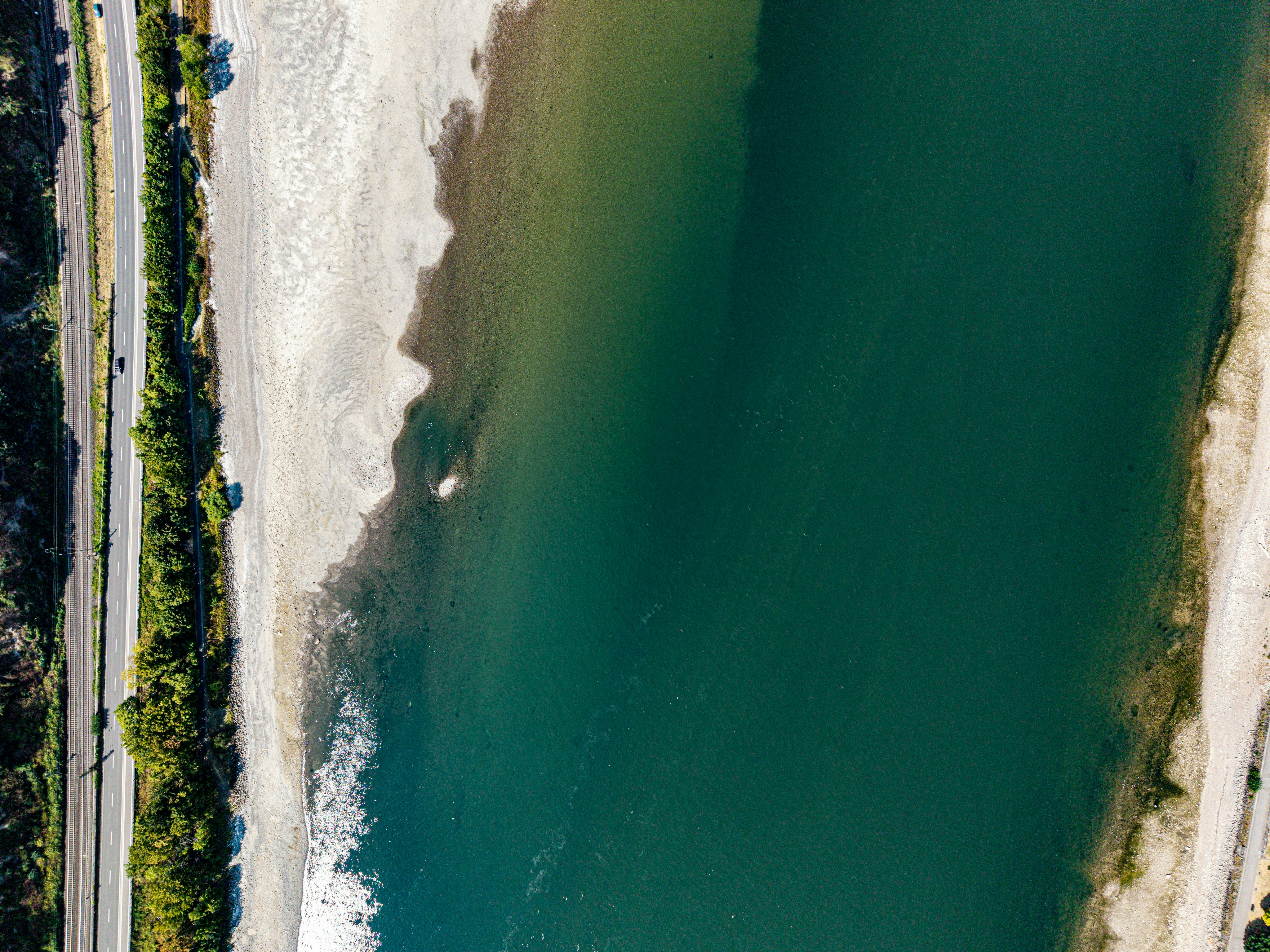 Riverbank Highway: Aerial Calm Along the Shore