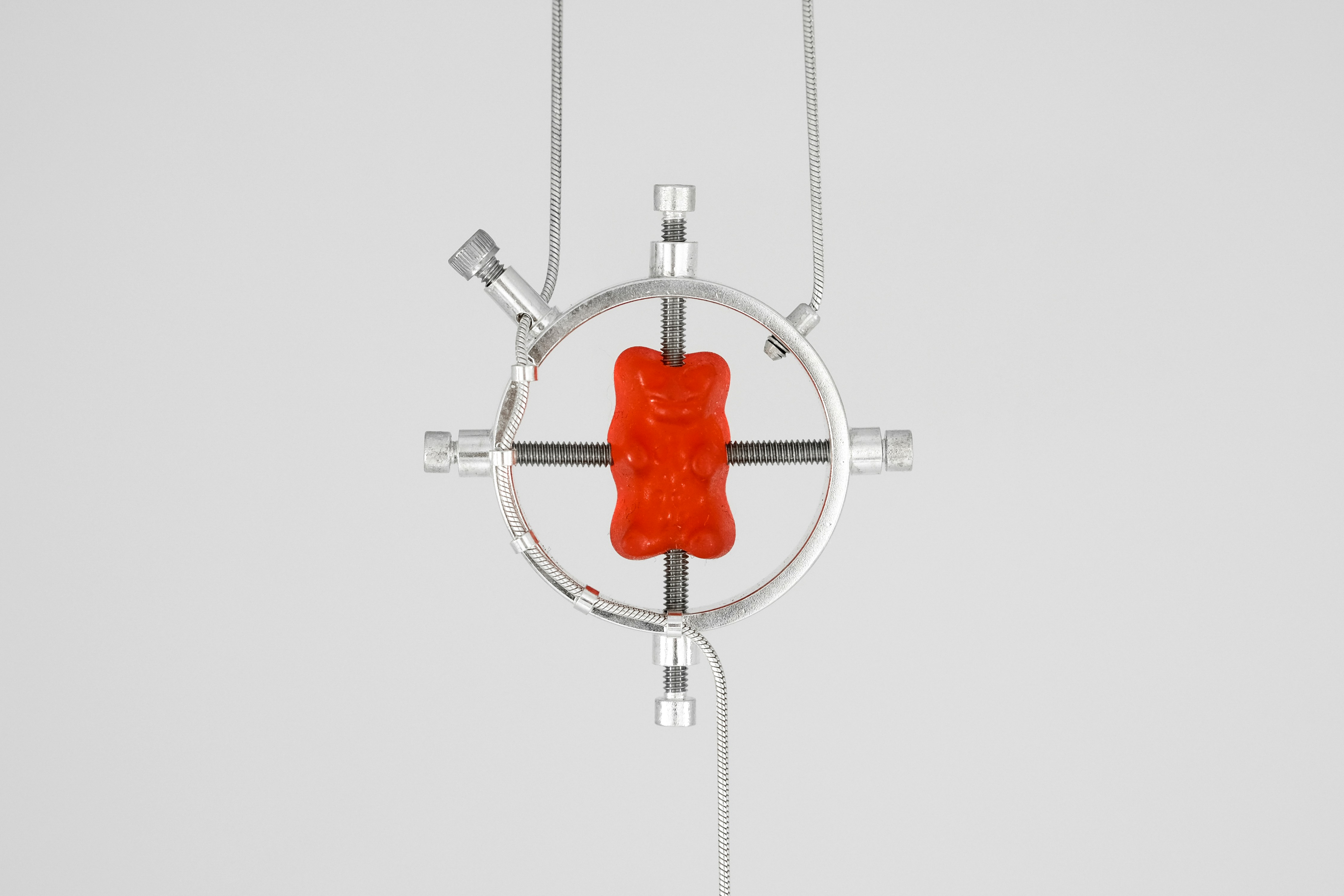 Circular Rig with Red Centerpiece: a Minimal Mechanical Pendant