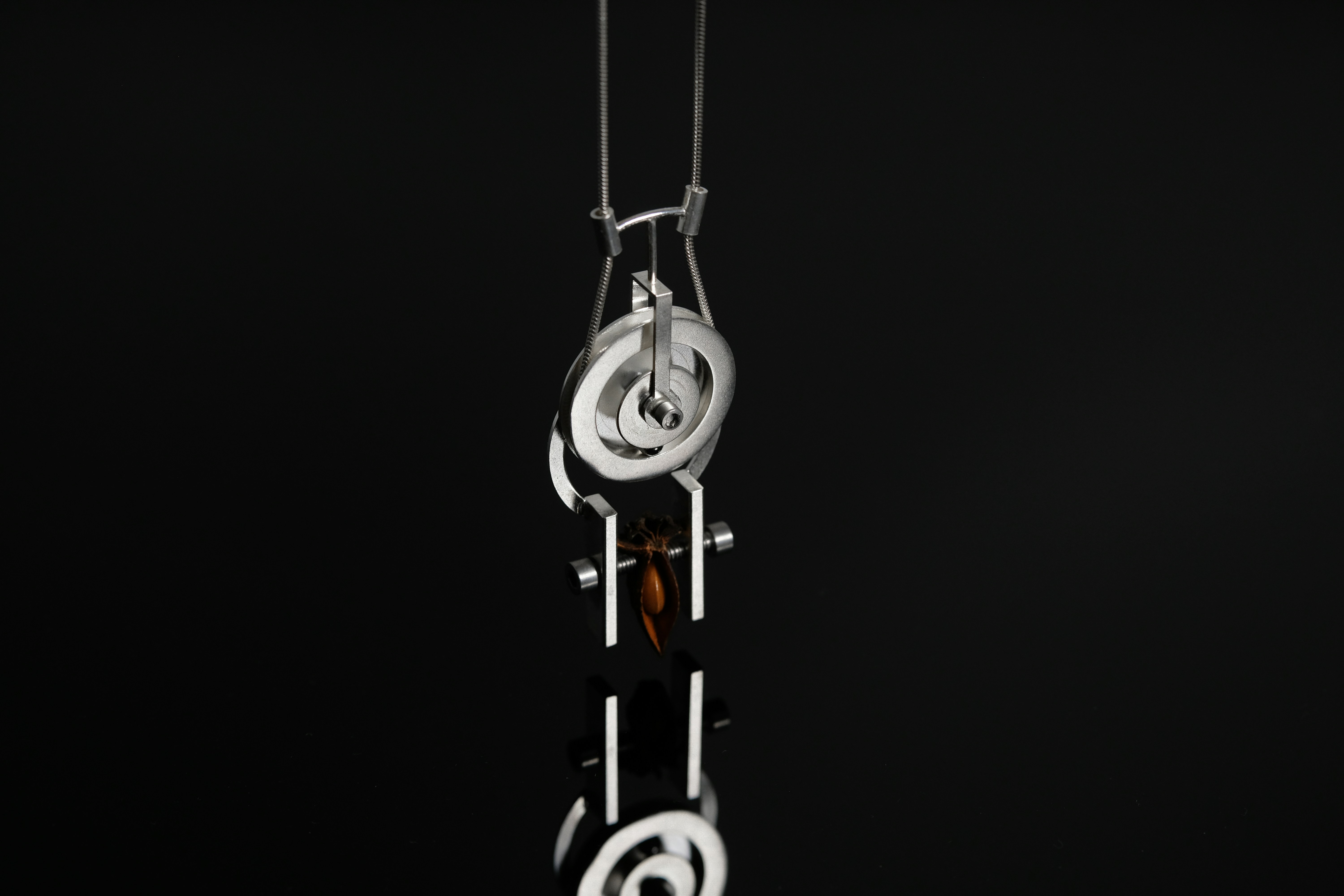 Hanging Orbits: A Minimalist Kinetic Sculpture in Shadow
