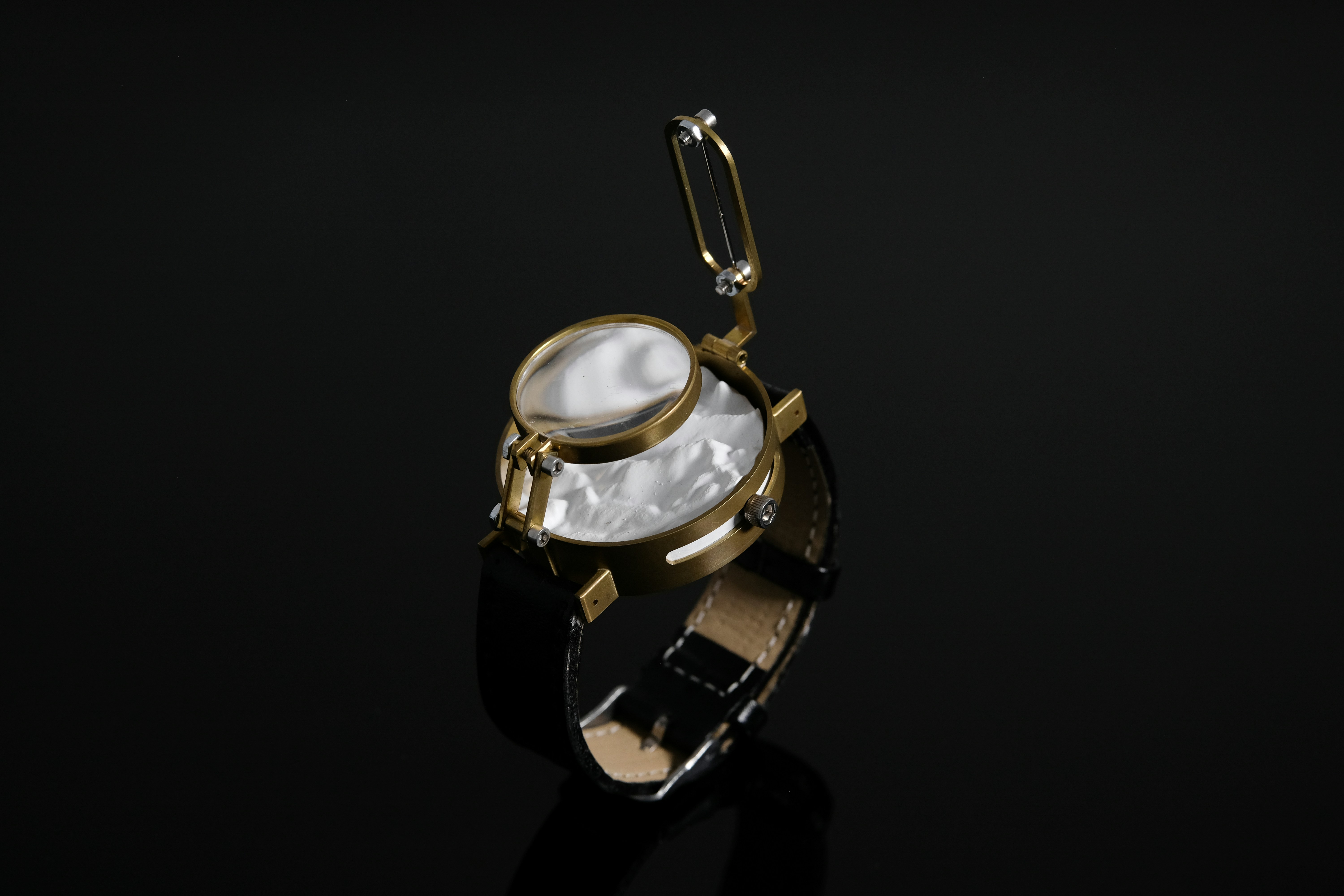 Midnight Lux: A gold magnifier crown on a black stage