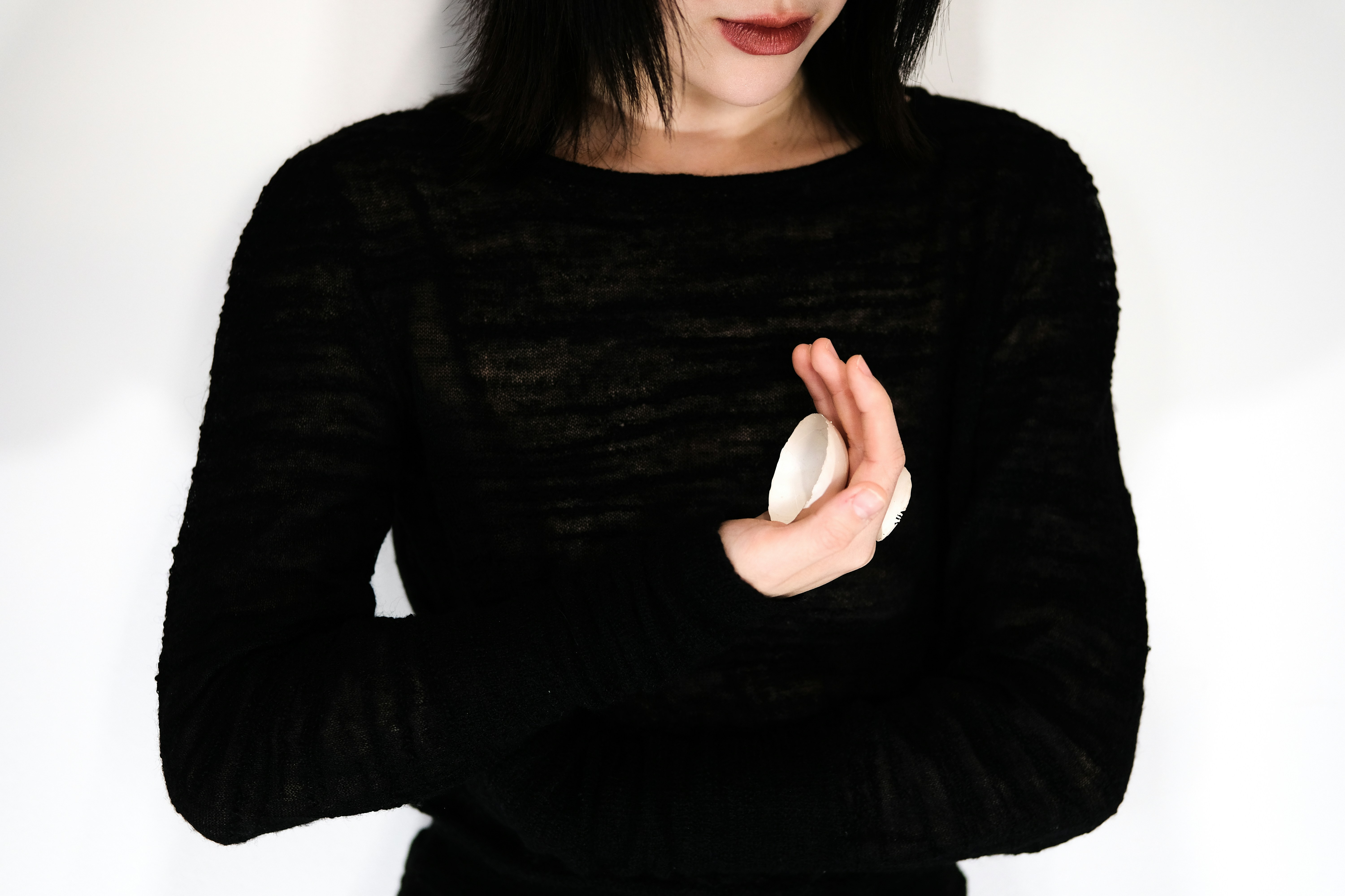 Silhouetted Hands and a White Crescent