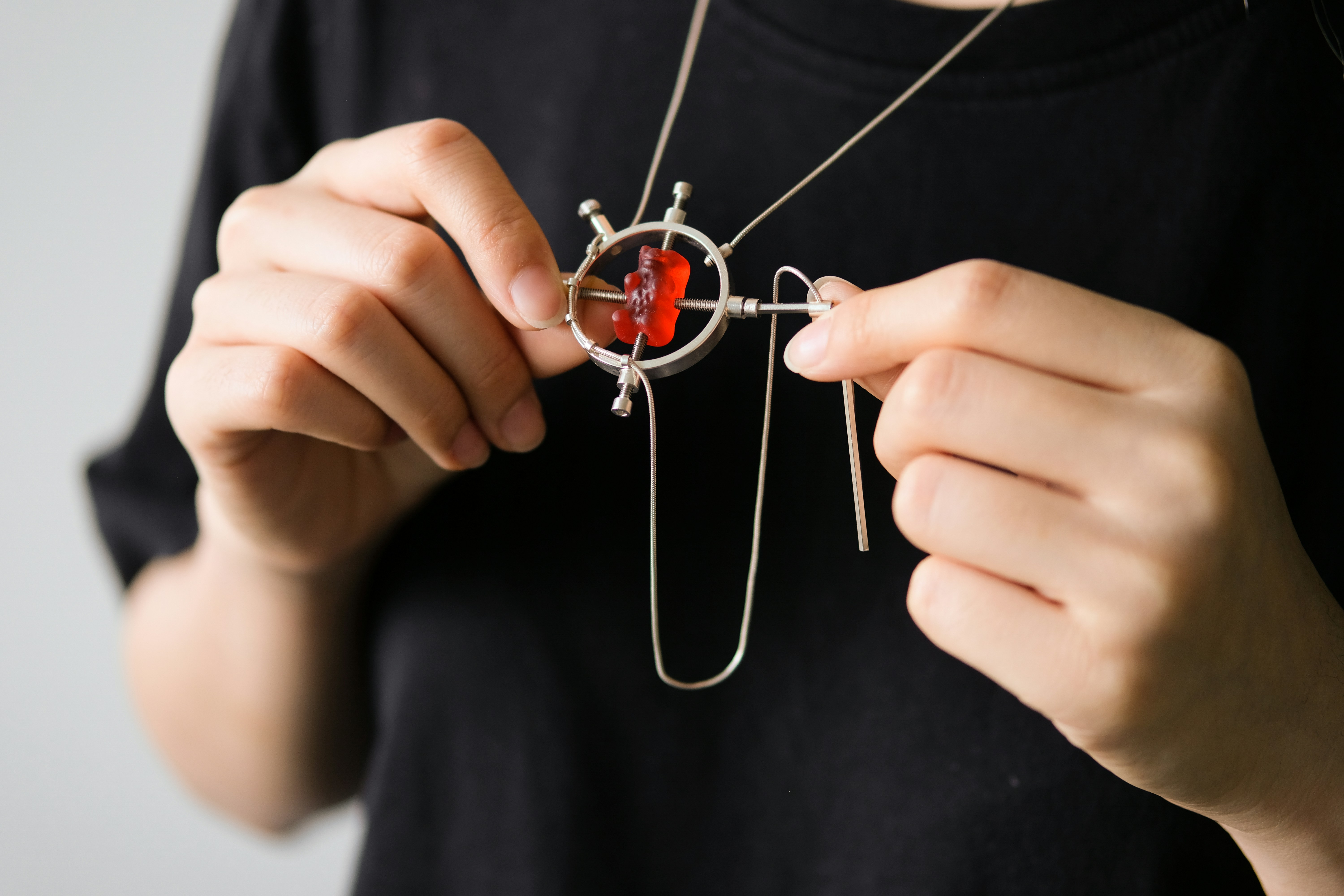 A delicate pendant clasped between careful fingers