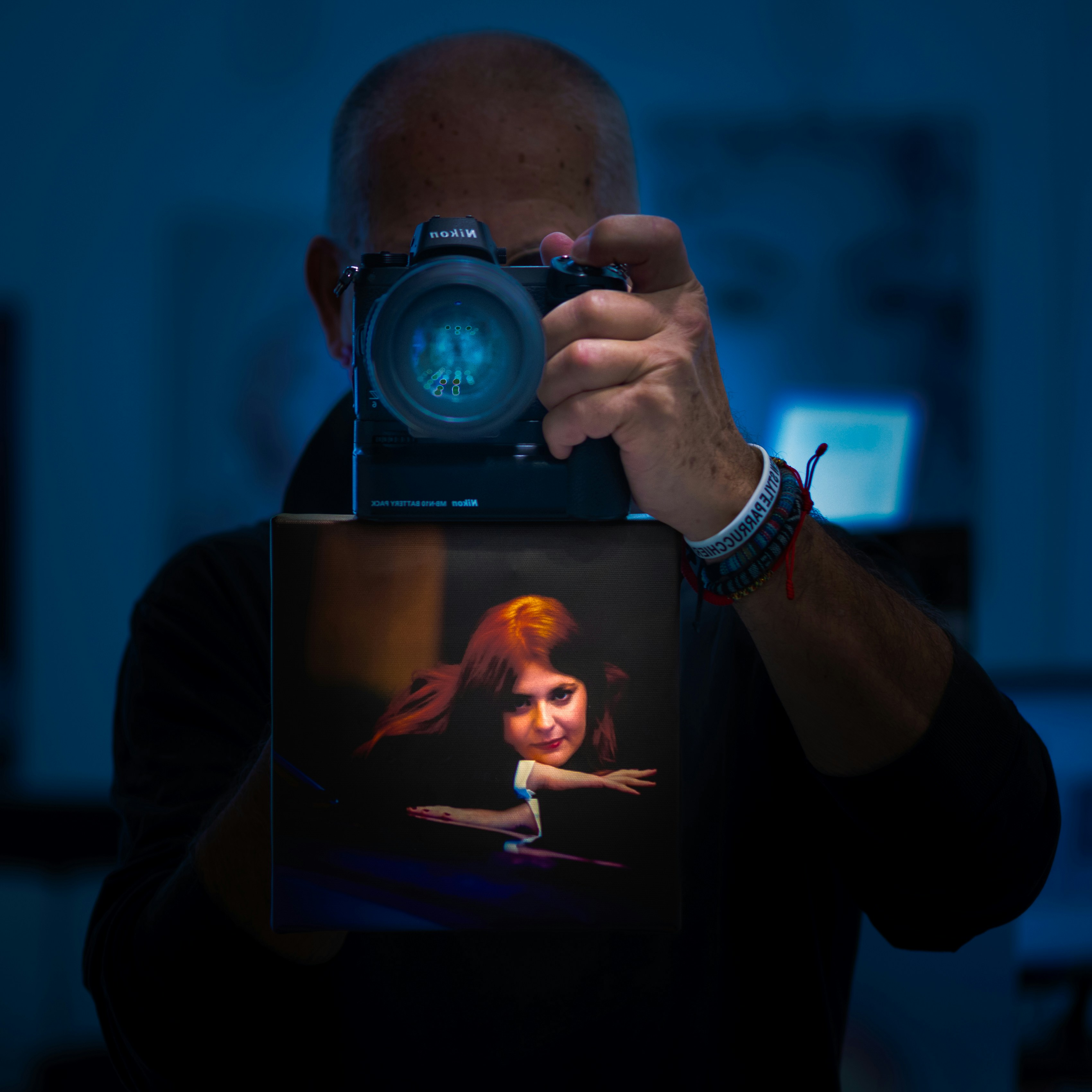 Portrait in a Shadowed Studio: A Polaroid Moment Emerges from the Lens