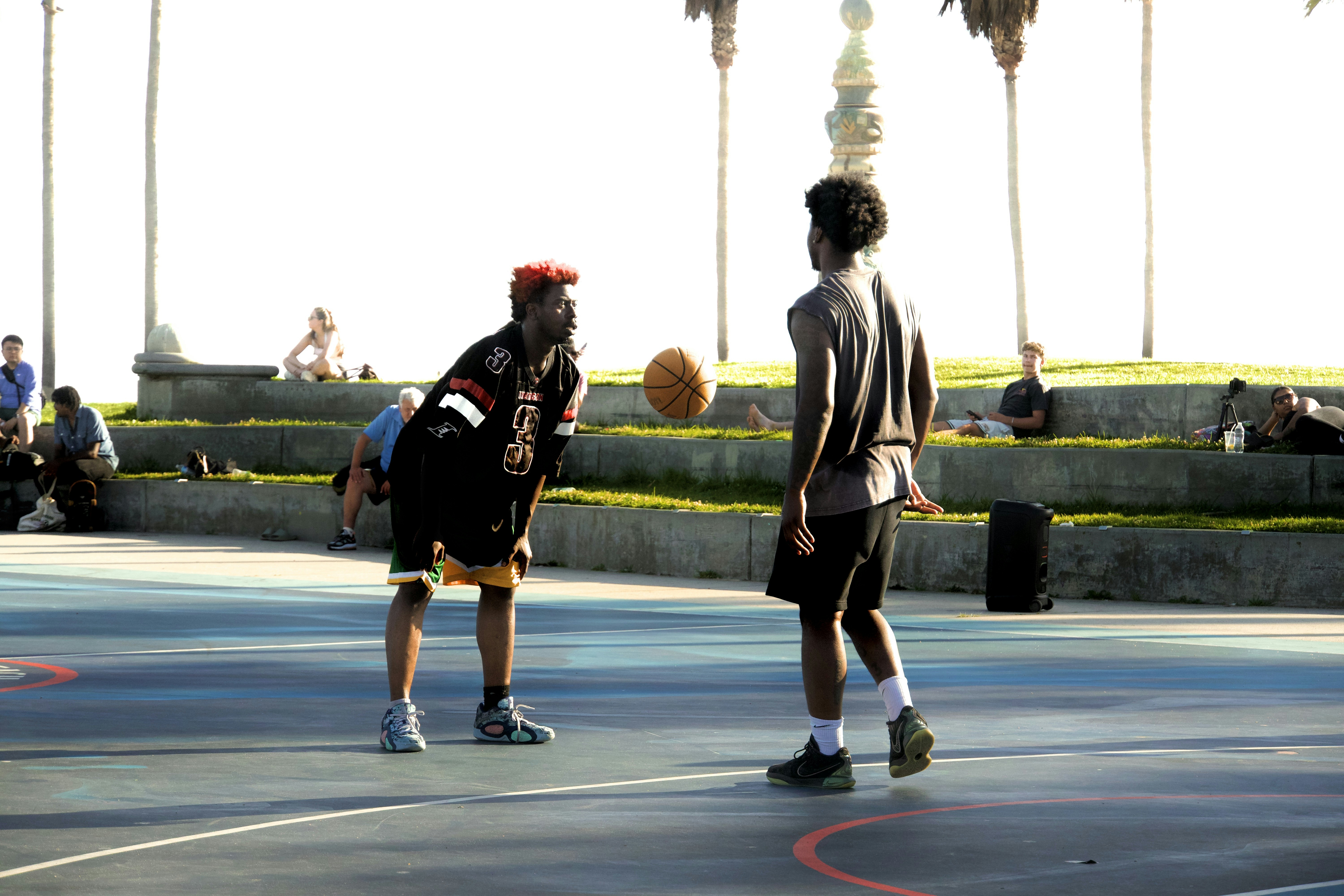 Courtside Showdown: Duel Over a Dribbled Moment on a Sunny Day