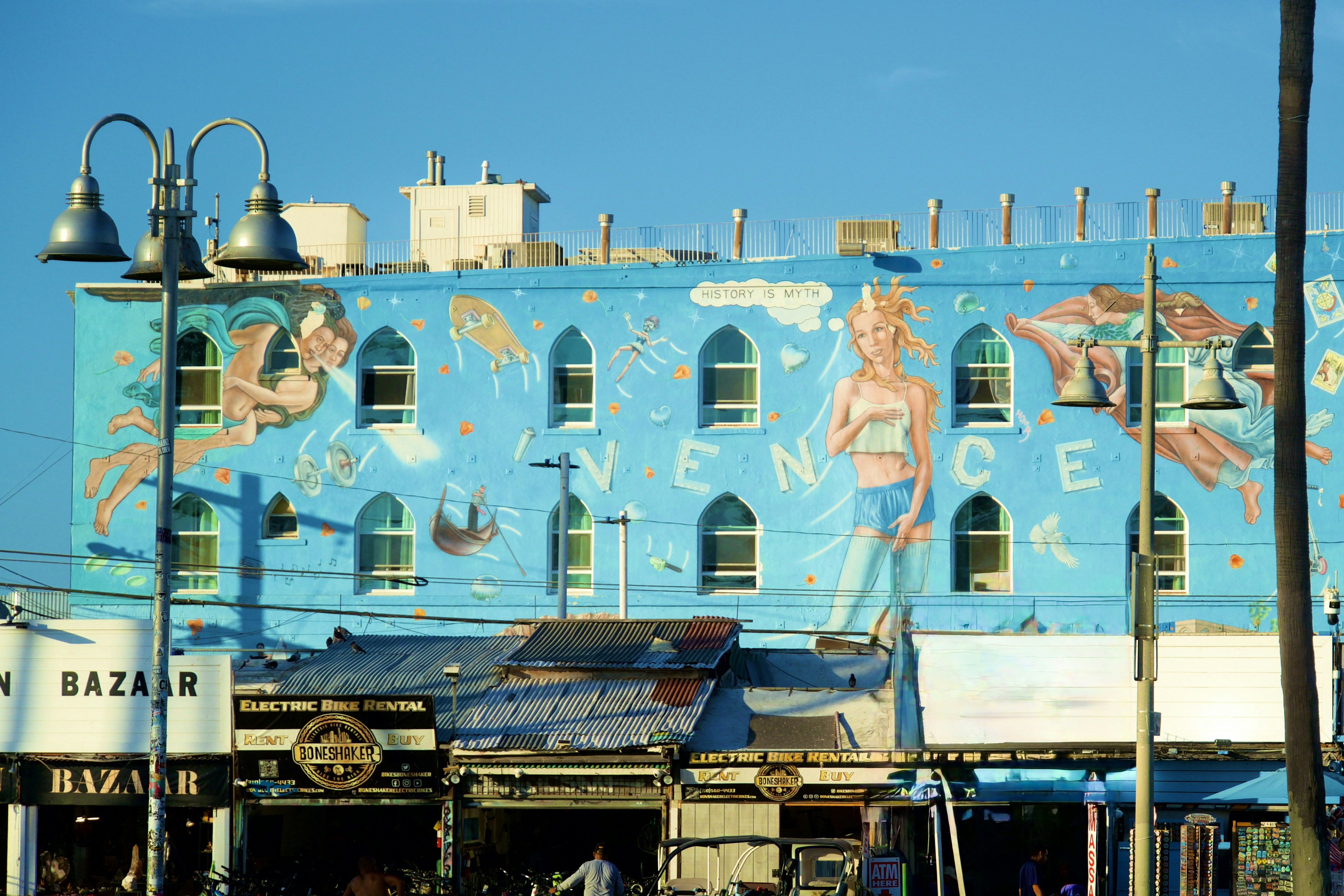 Vibrant Oceanside Murals Over a Bustling Market