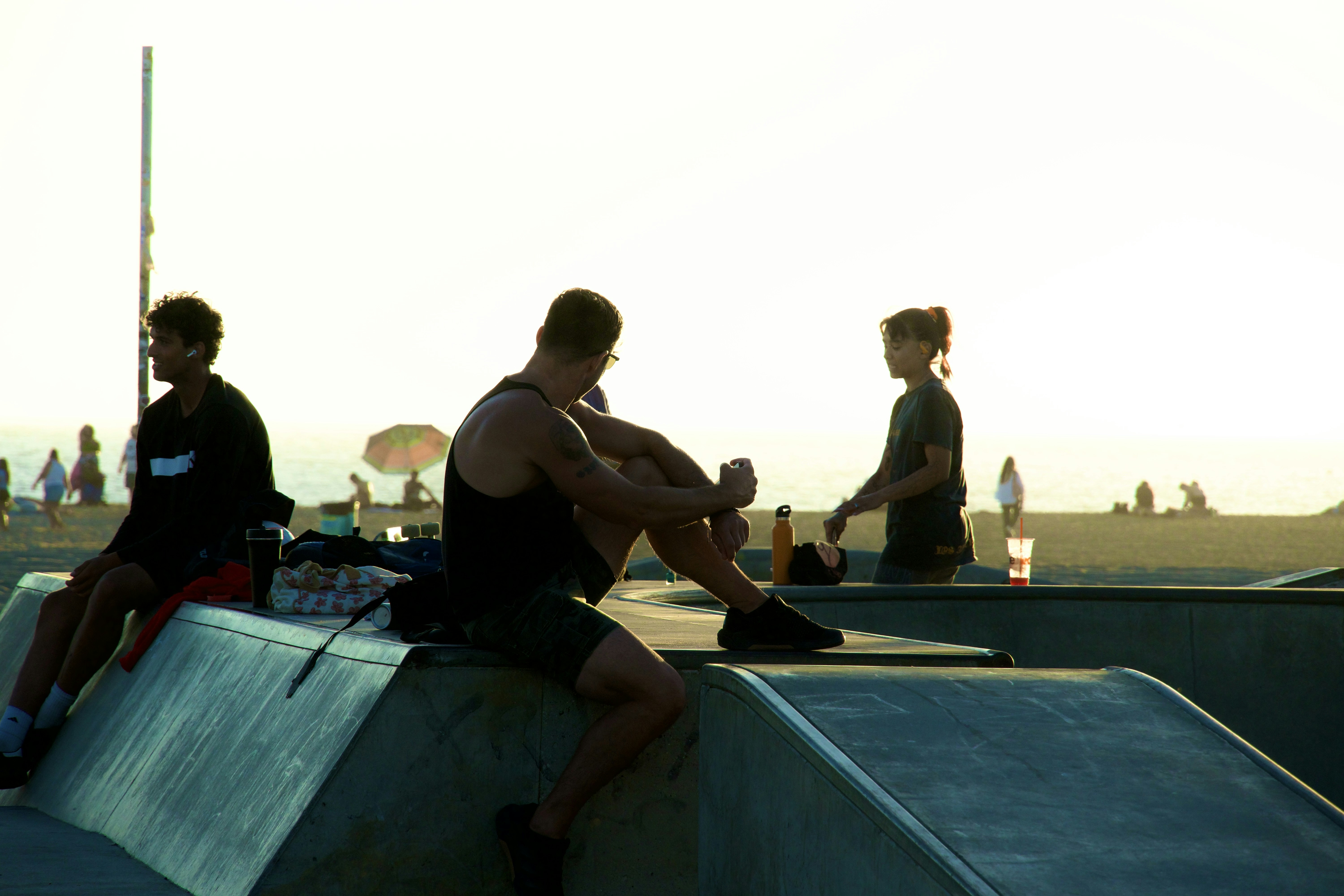 Sunlit silhouettes at the skate park by the sea