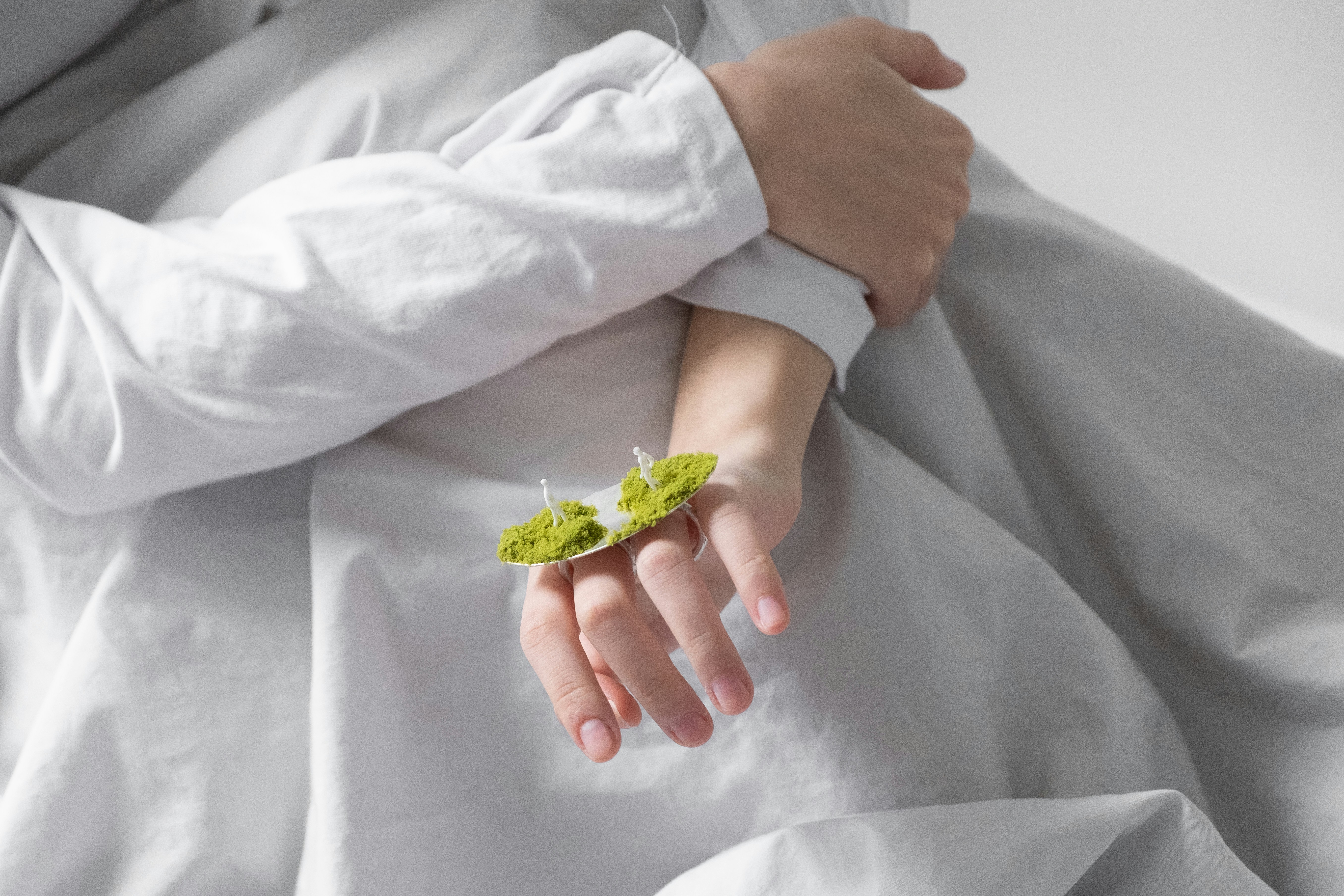 Gentle Embrace: A Bare Arm Resting with a Leaf-Bloom