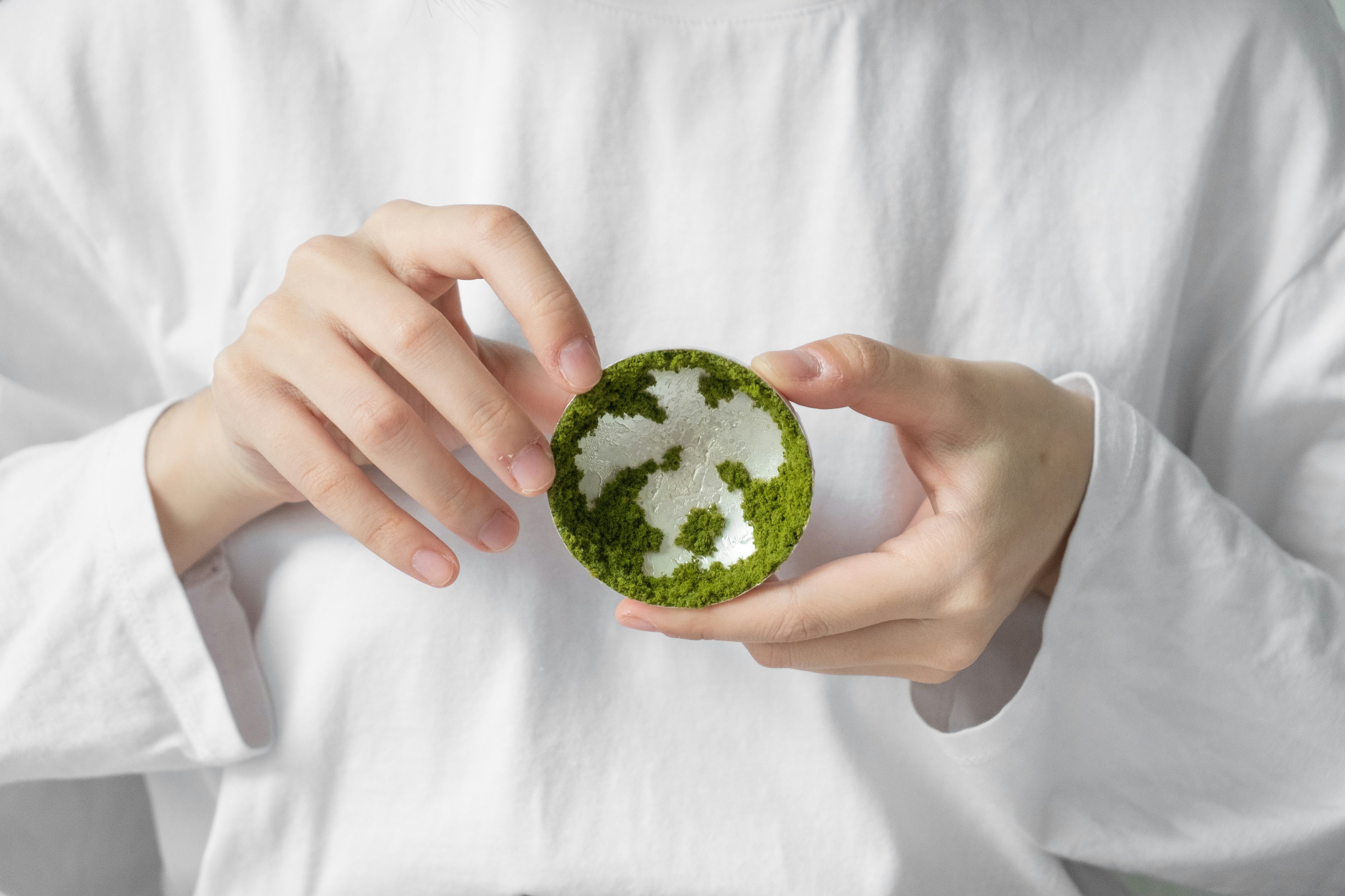 Moss Portrait: A Green Mosaic Framed by Gentle Hands