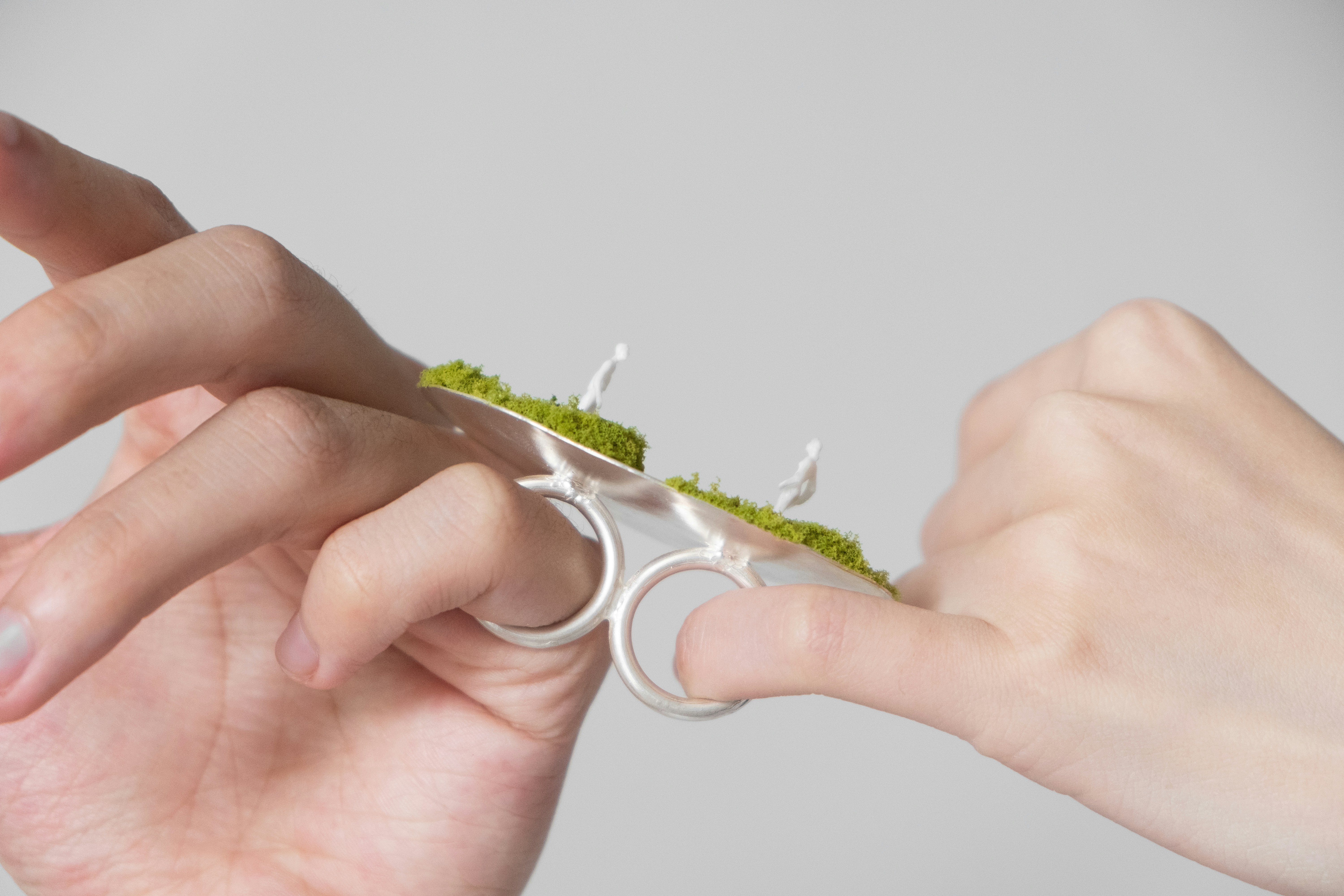 Tiny green moss, sharp steel: a close knit moment of precision