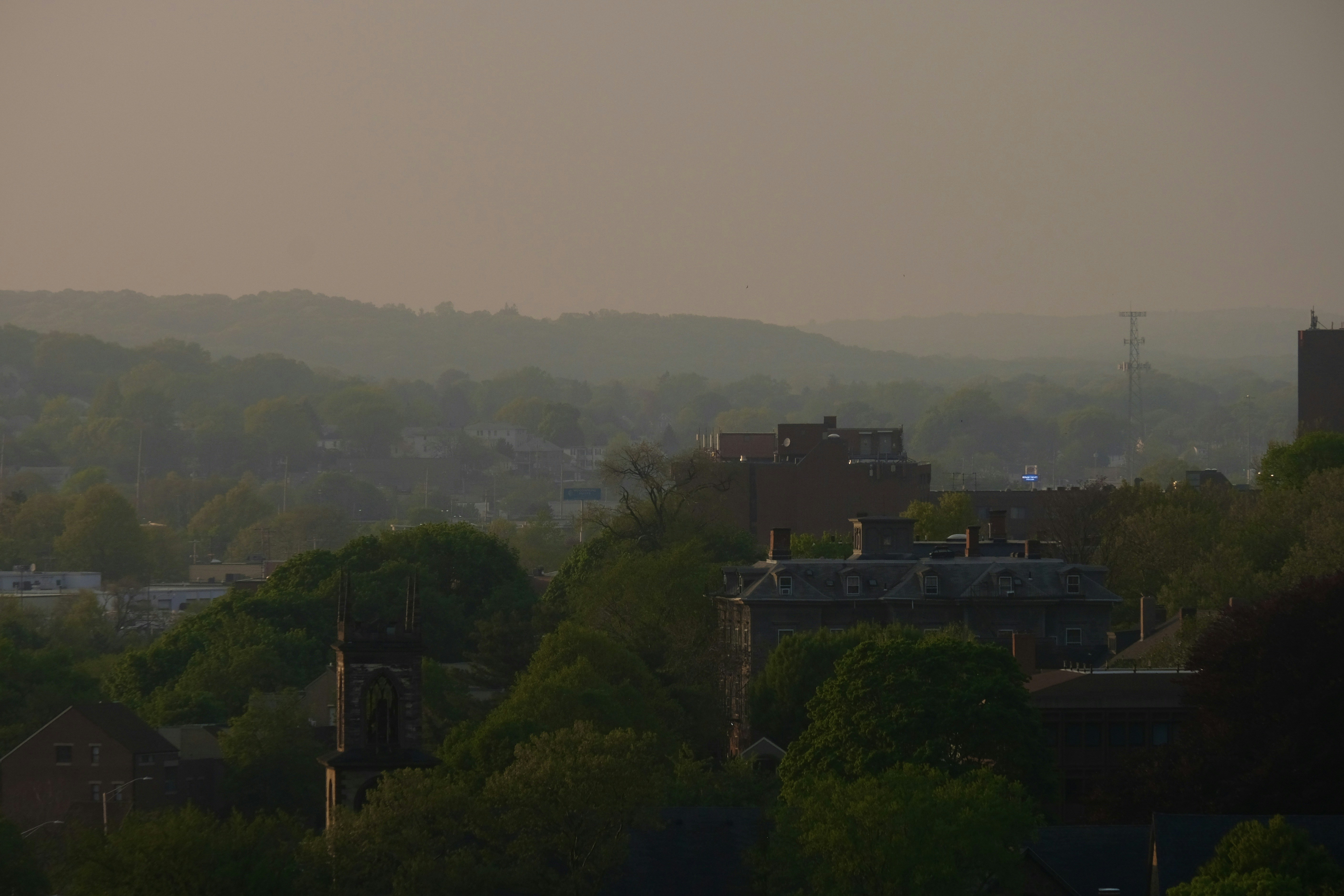 Dusk over the Quiet Campus: A distant silhouette of trees and buildings