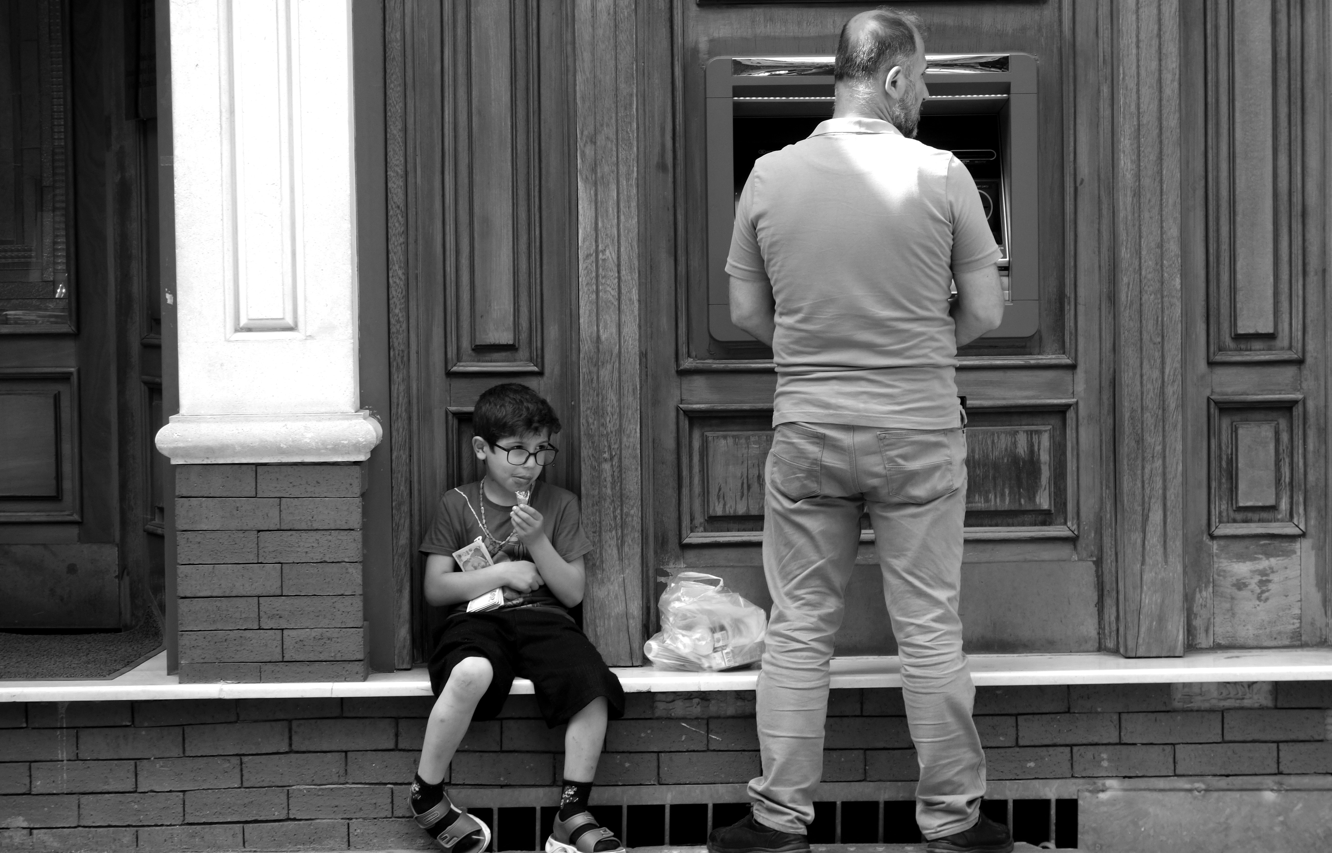 Two Worlds at a Window: A Quiet Break on a City Step