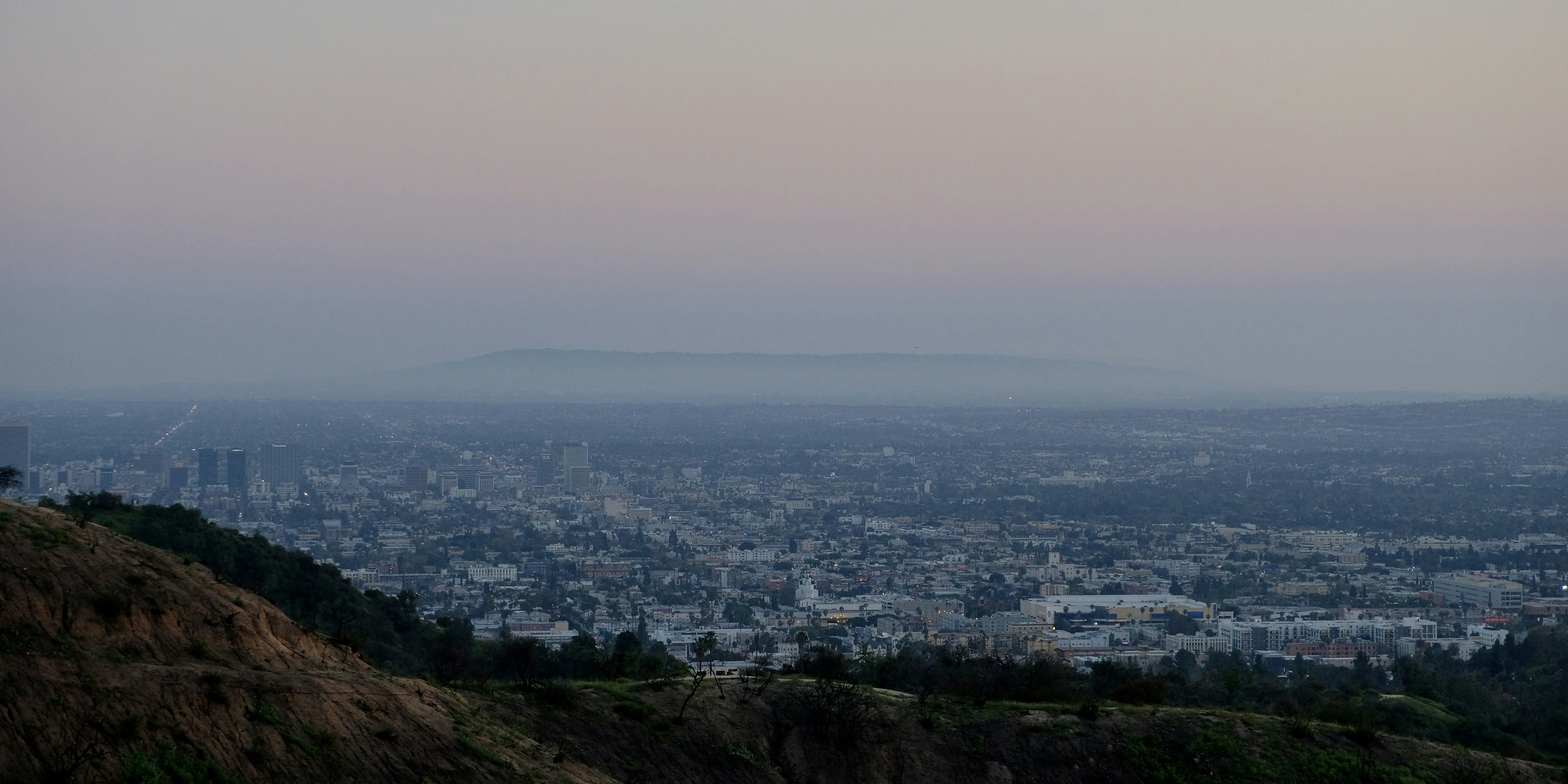Rooftops and Ridge: A City Folds into the Horizon at Dusk