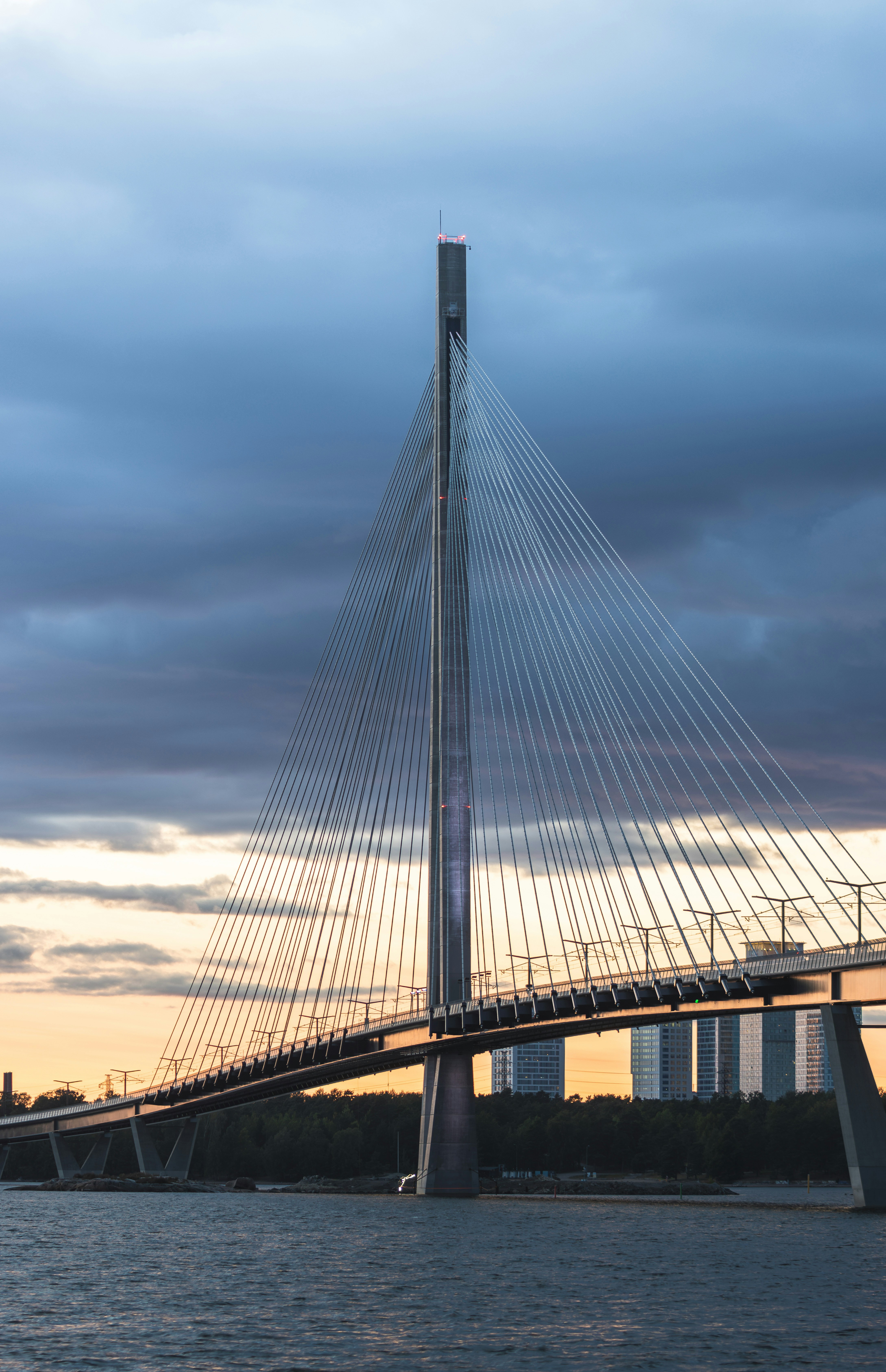 Cable-stayed Sentinel Over Still Waters at Dusk