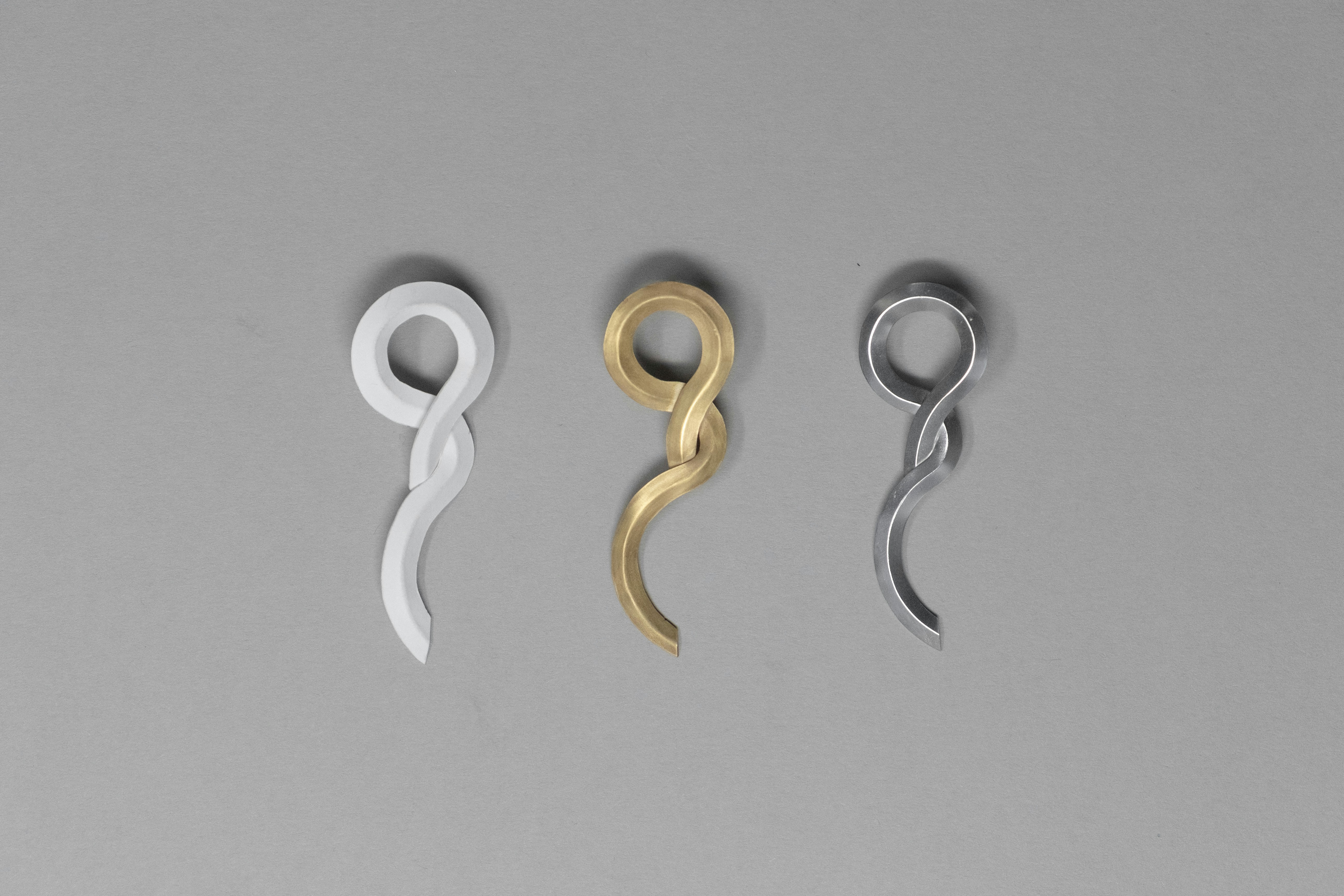 Three-toned S-Curve: A Minimal still life of metallic hooks