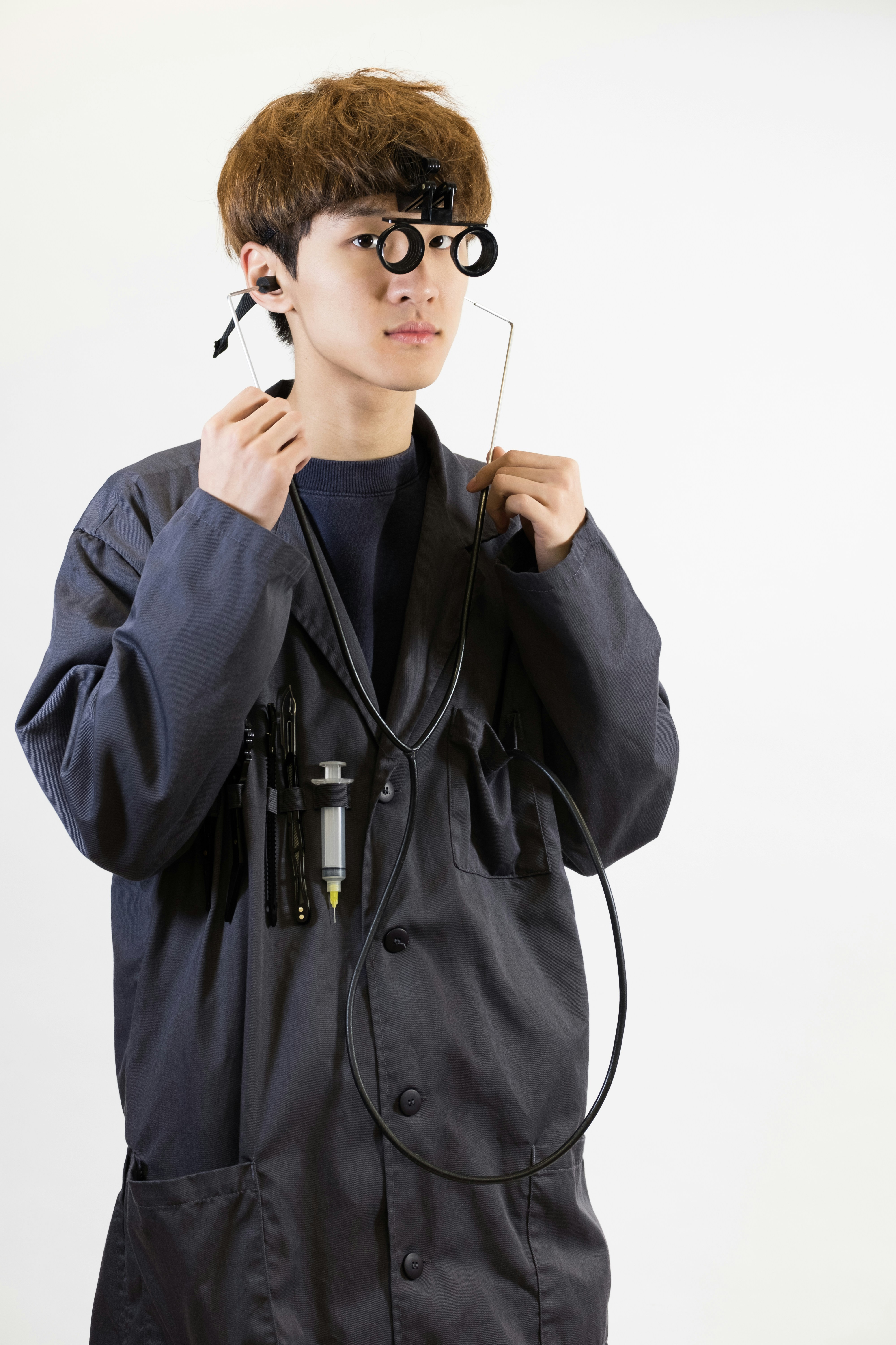 Gadgeted gaze: a maker adjusts the viewfinder on a futuristic headset