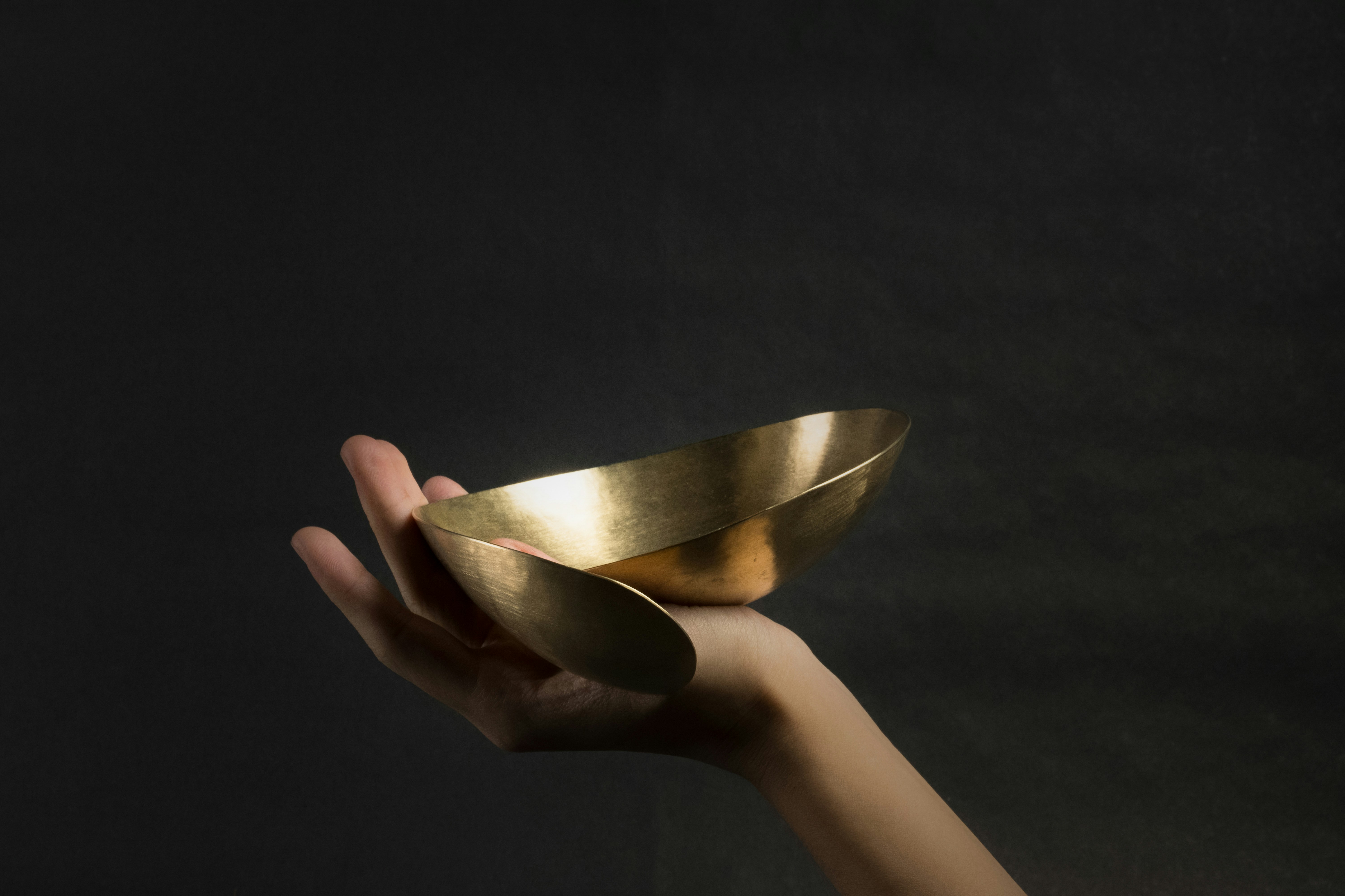 Gilded Balance: A Gentle Hand Presents a Copper Bowl