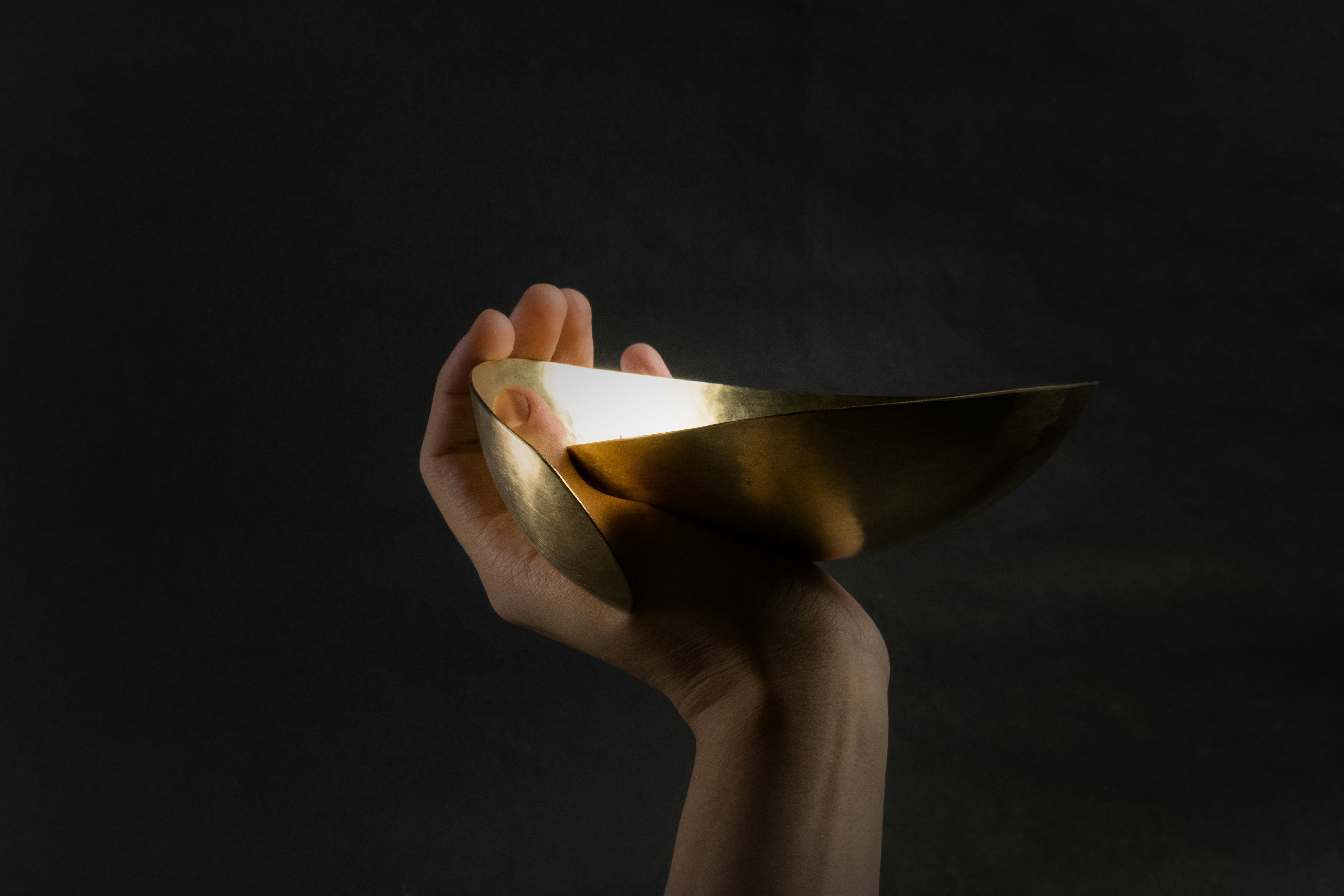 Copper Vessel in Hand: A Quiet Study of Light and Grip