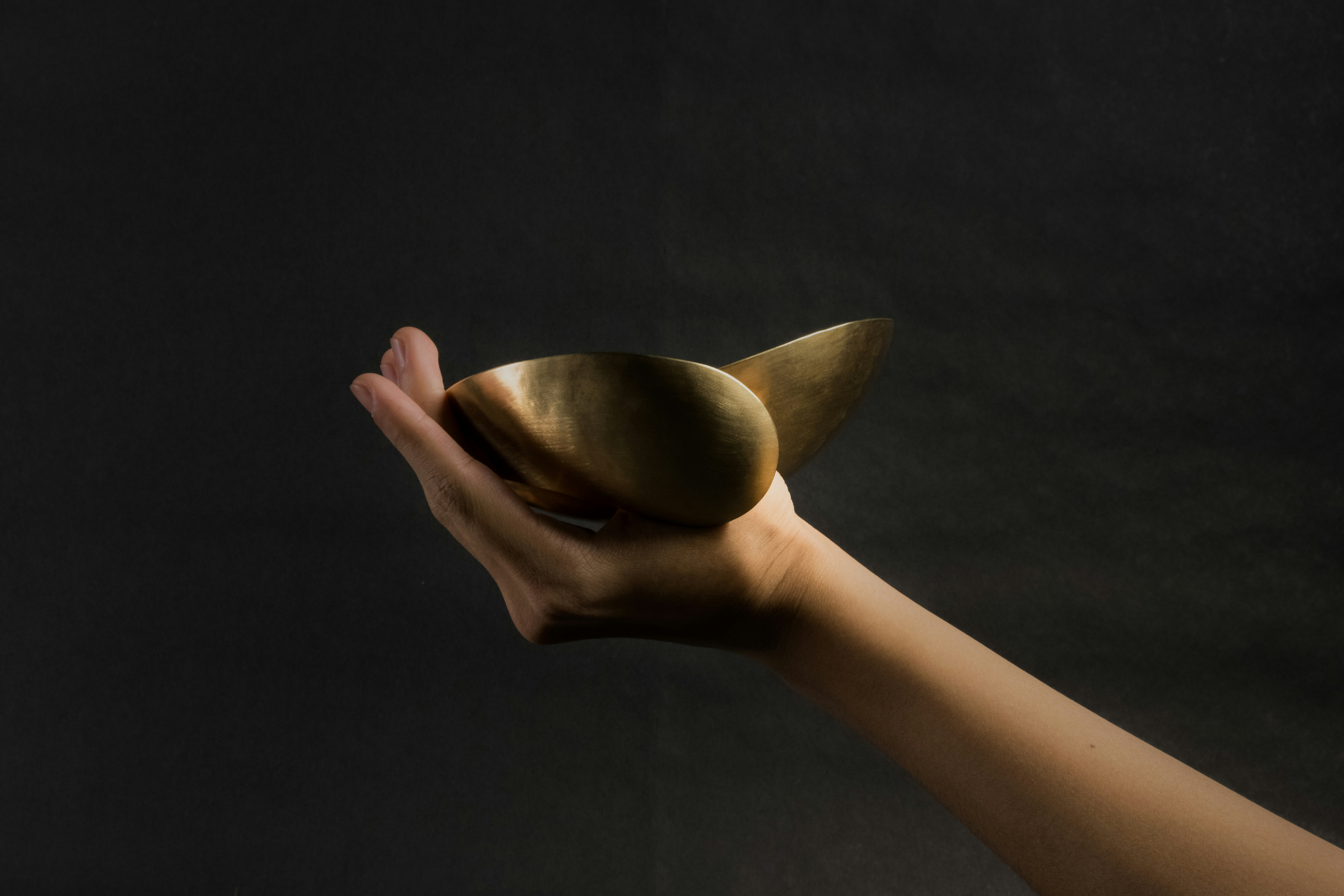 Gold Vessel in a Gentle Grasp
