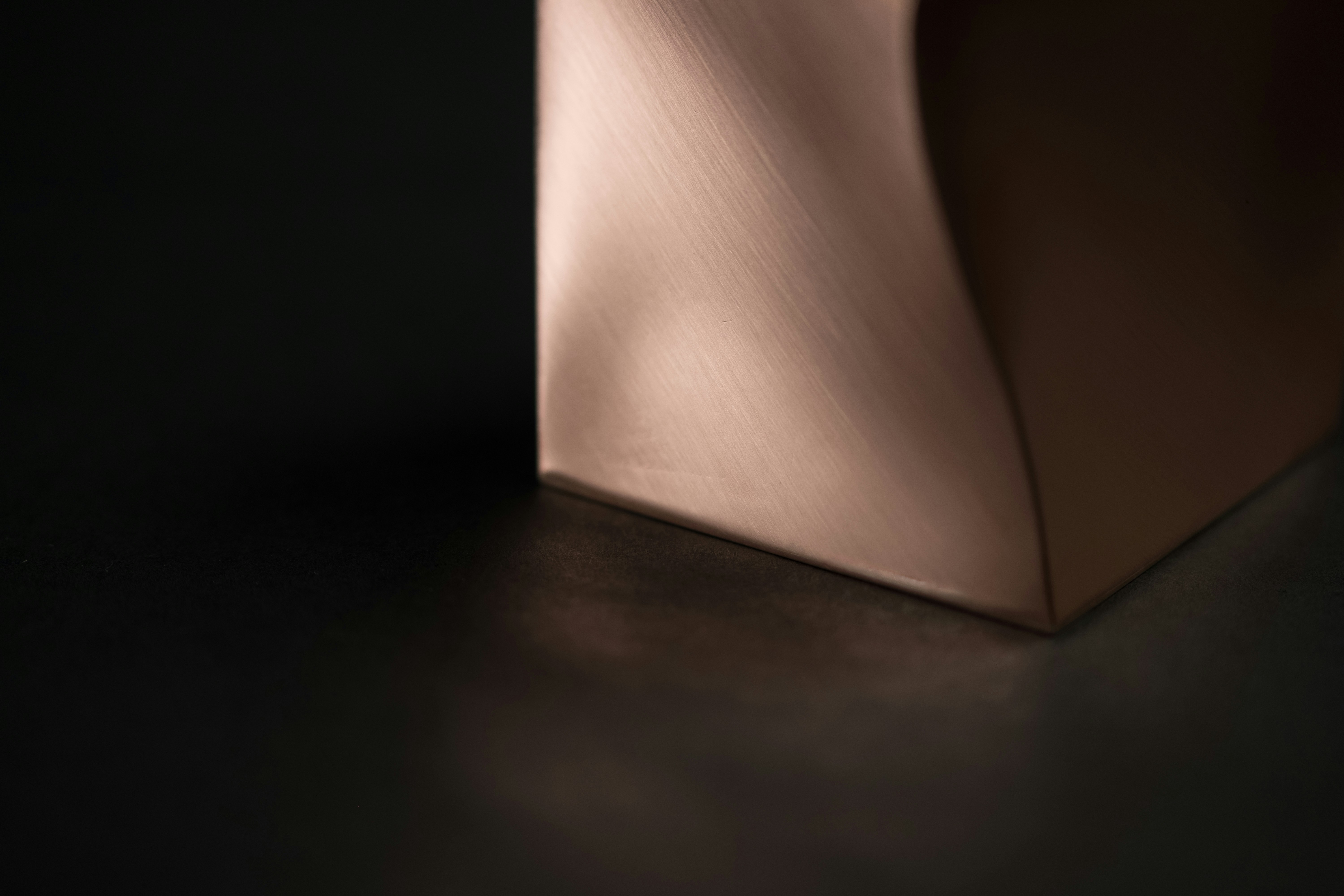 Geometric Copper Edge Emerging from Darkness