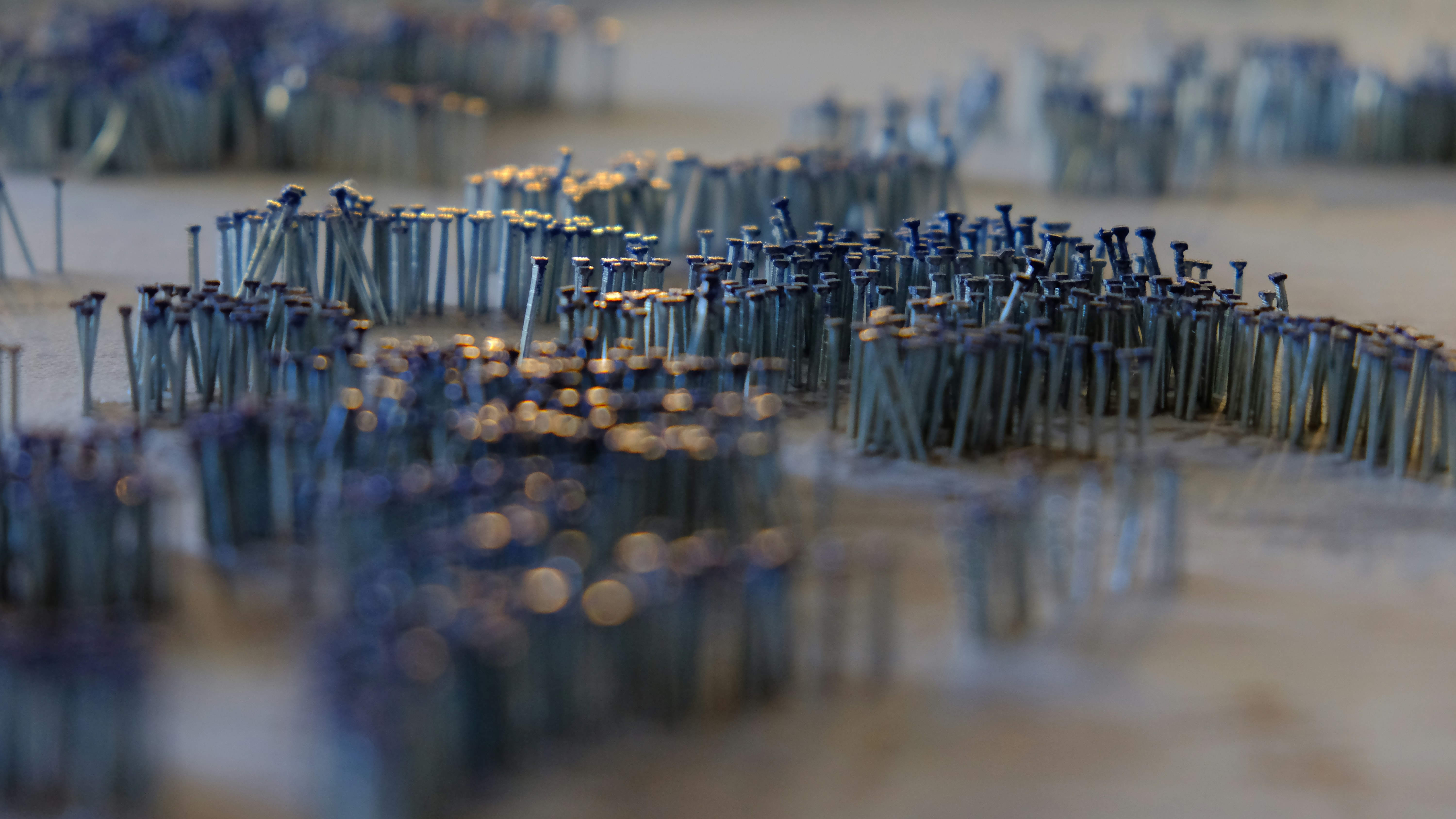 Buzzing Sea of Pins: An Ocean of Shimmering Nails on the Beach