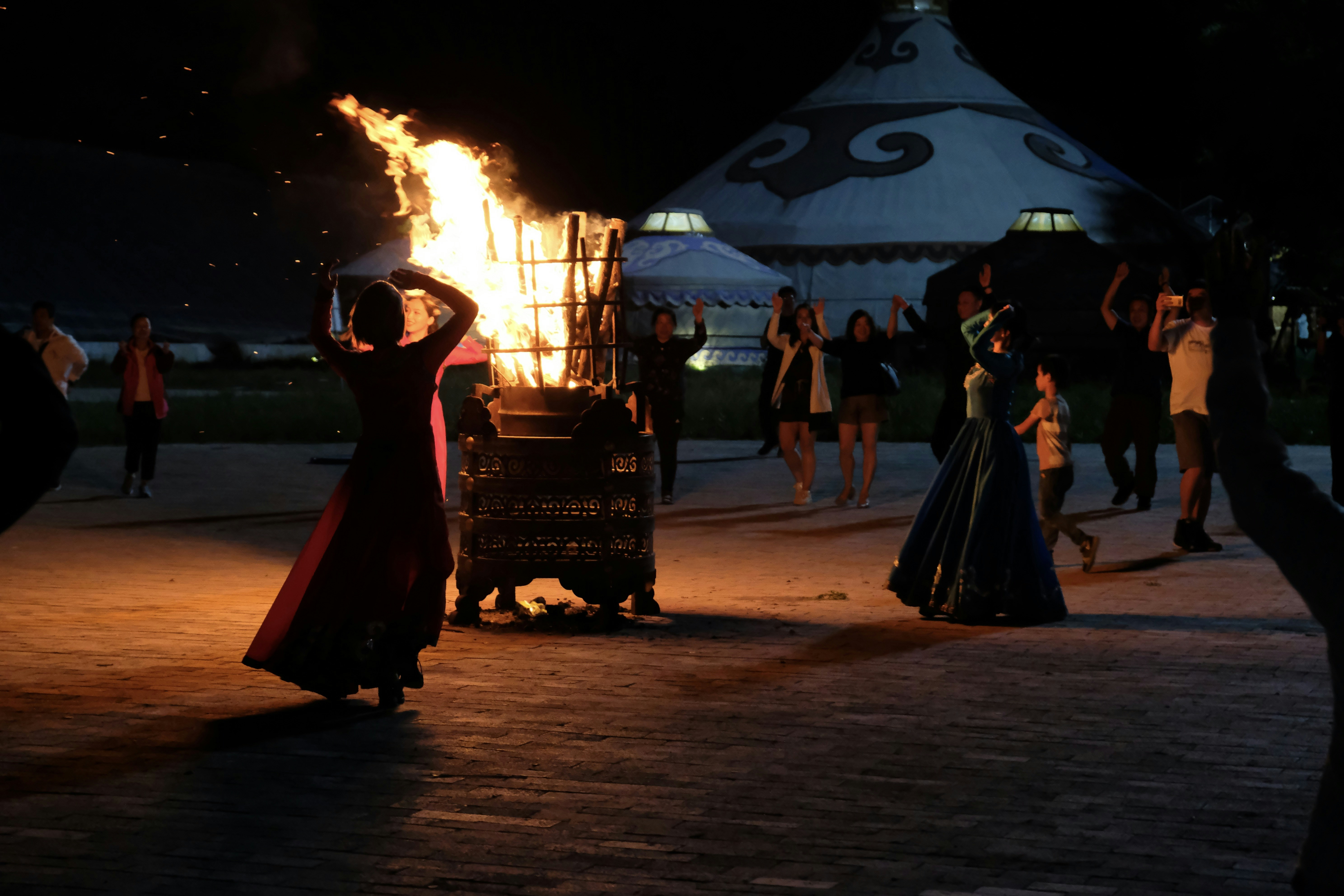 Flames and Festivities: Dancers Framing a Fire Ritual at Night