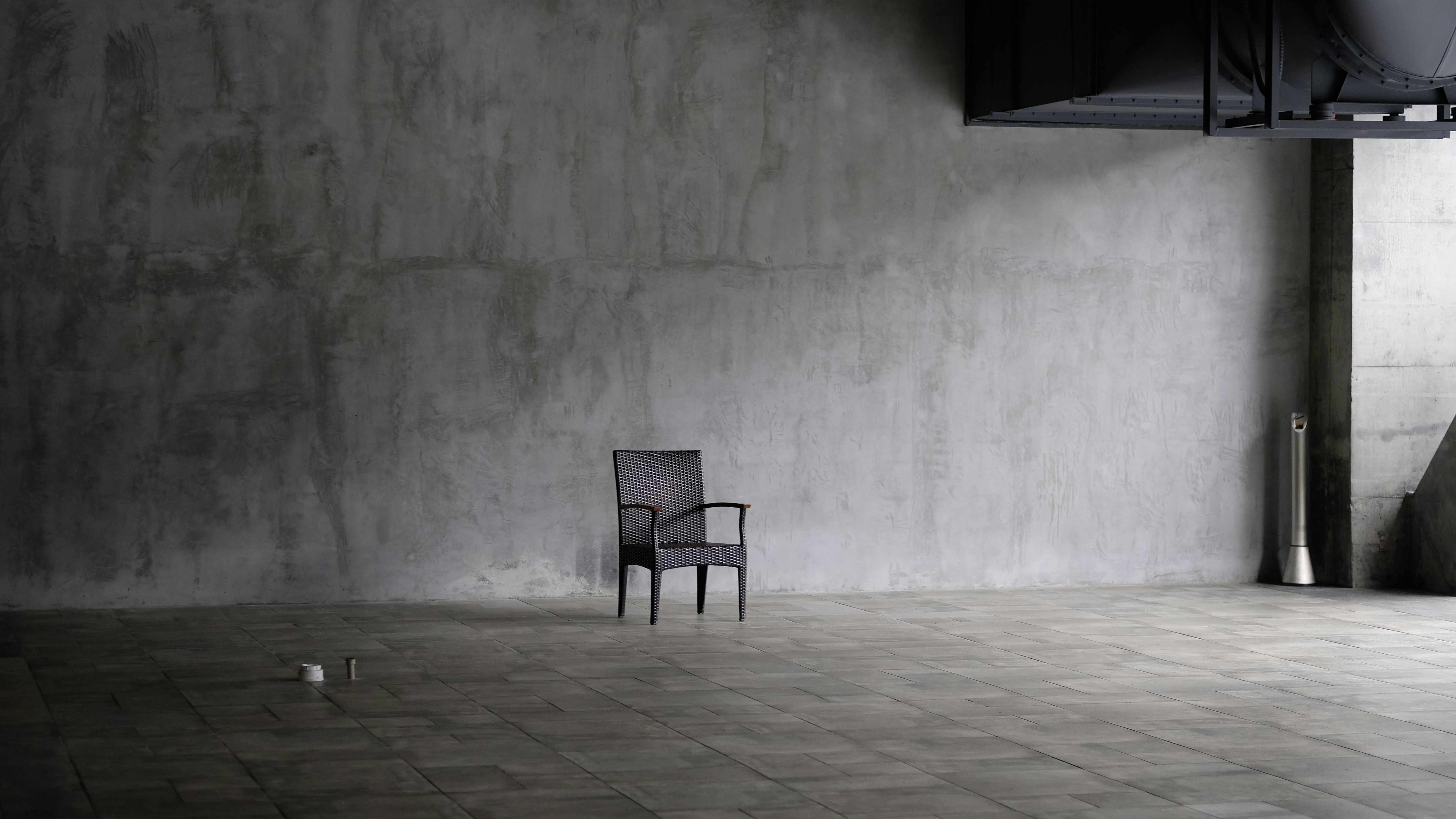Solitary Chair in a Mission-Concrete Corridor