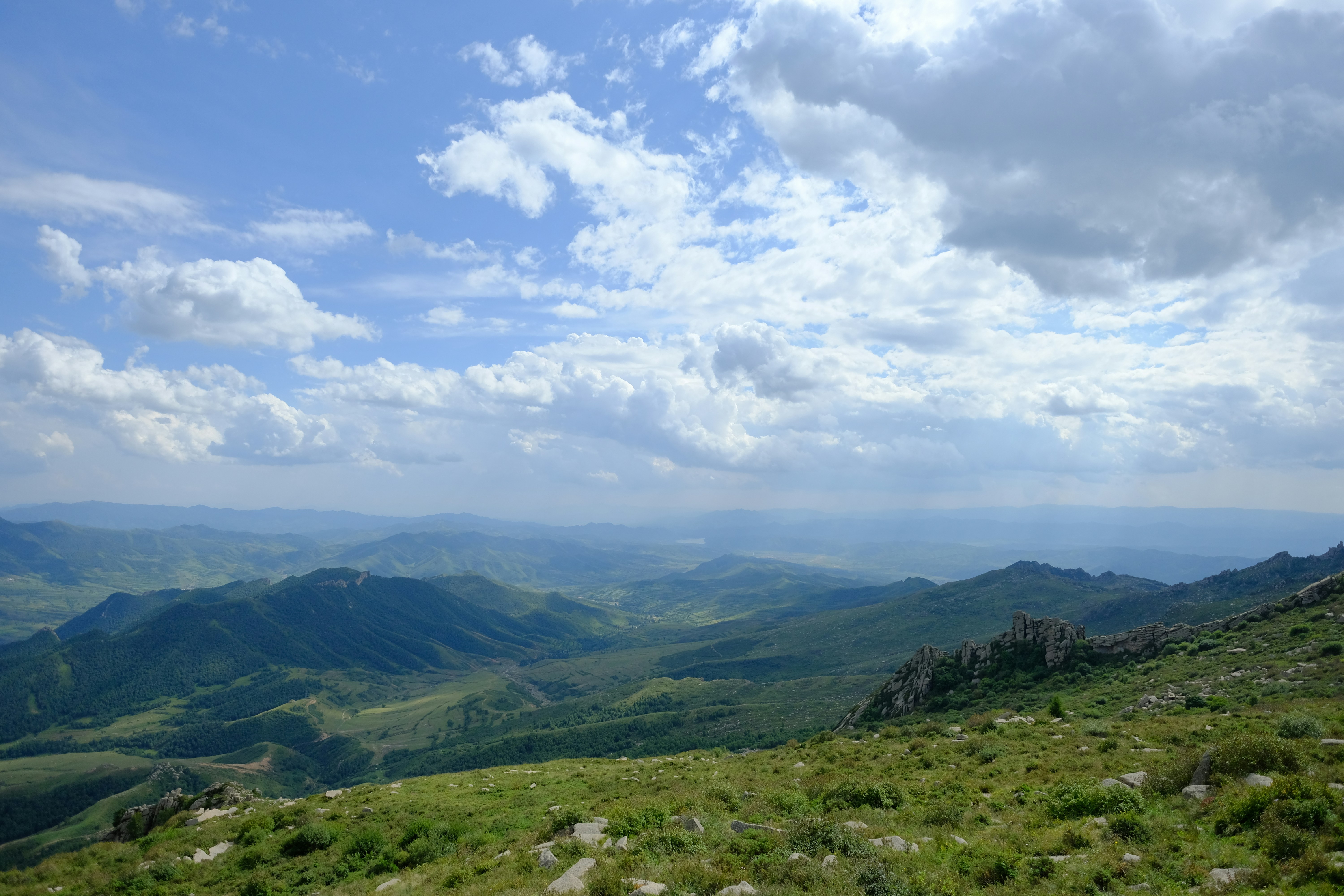 Verdant Horizon: Rolling Hills Under a Crown of Clouds