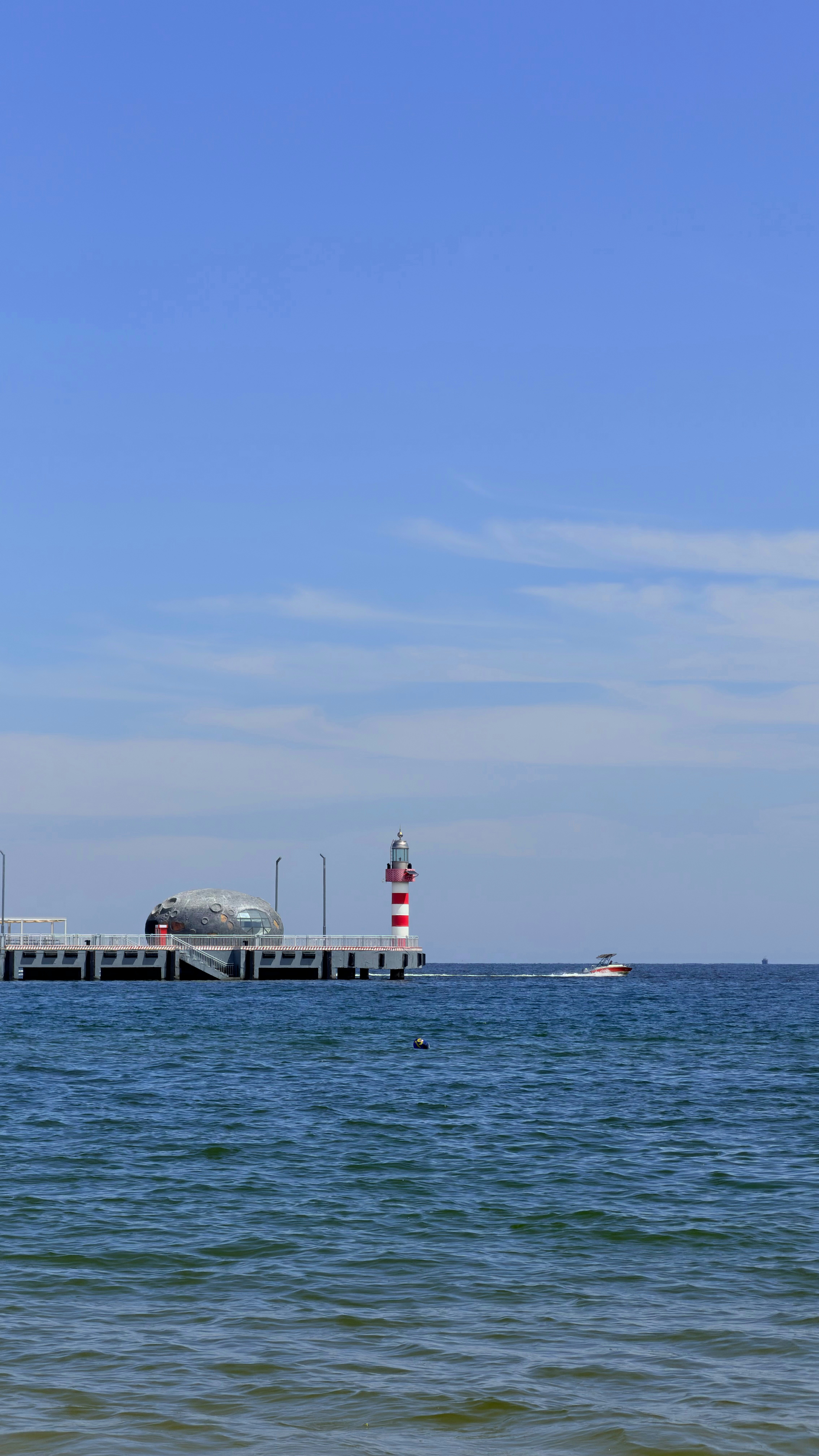 Pier and Lighthouse at Dusk-blue Horizon