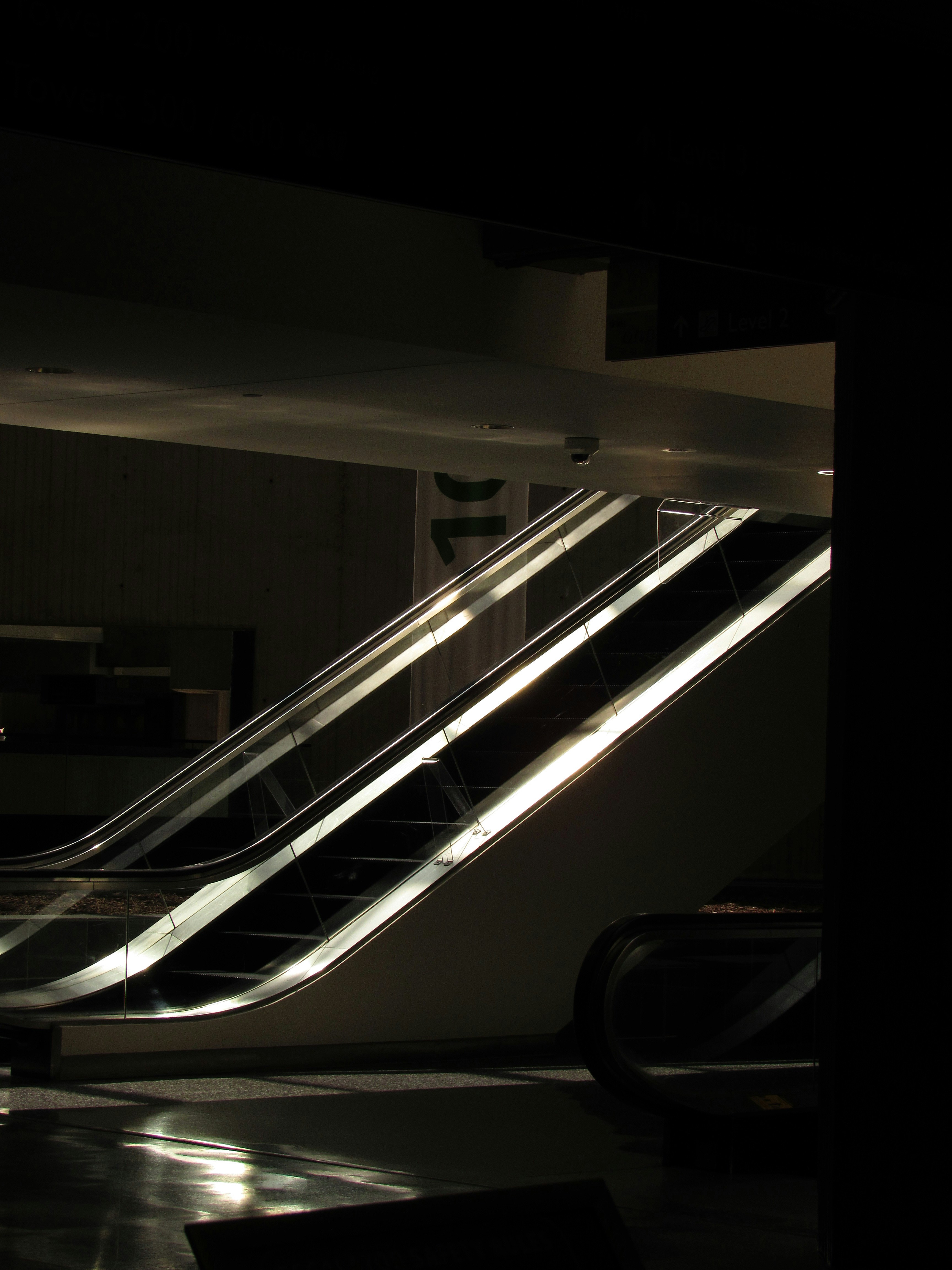 Silent Slopes of Light: Escalators in a Dim Mall
