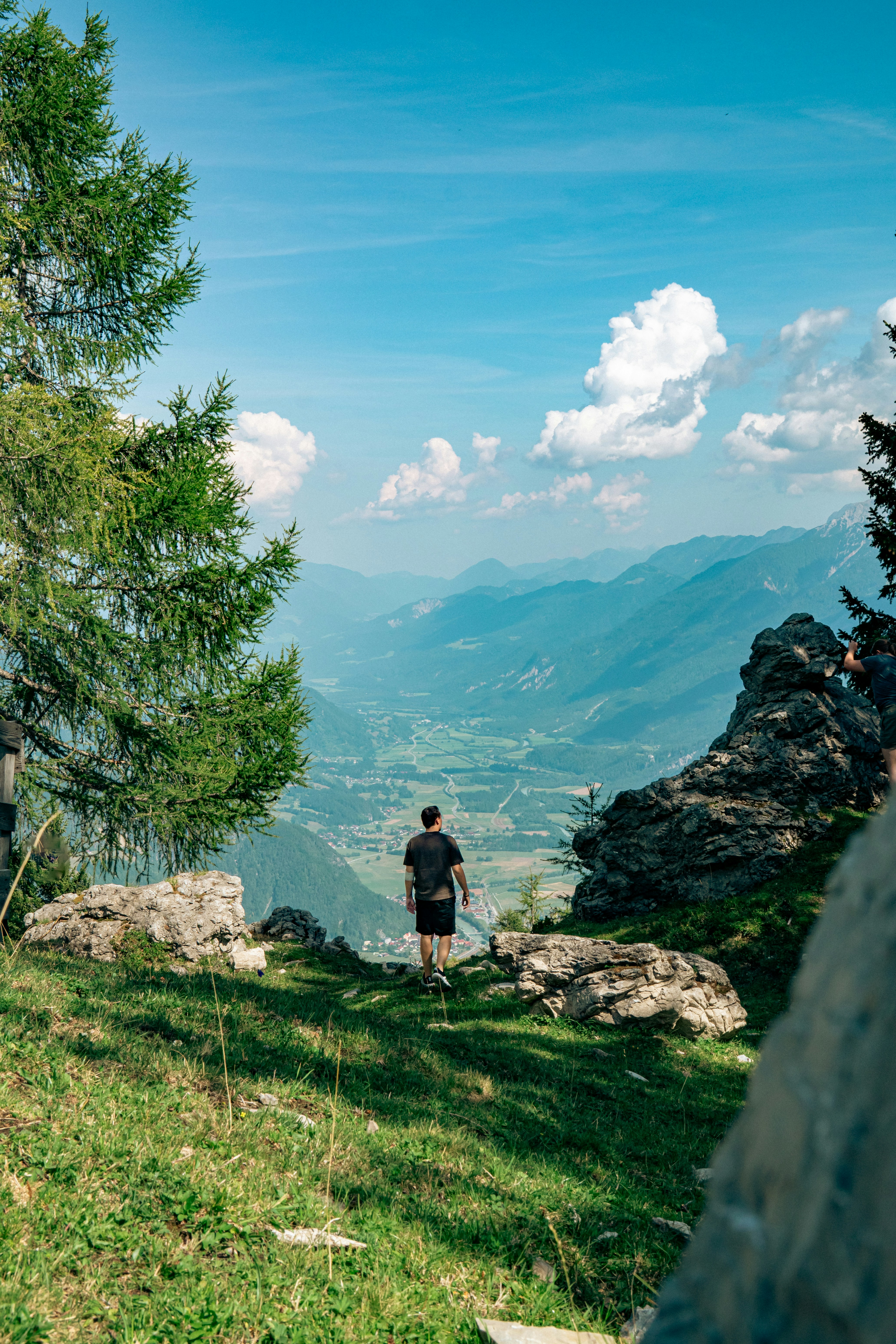 Hikers' View: A Lone Wanderer at the Edge of Alpine Expanse