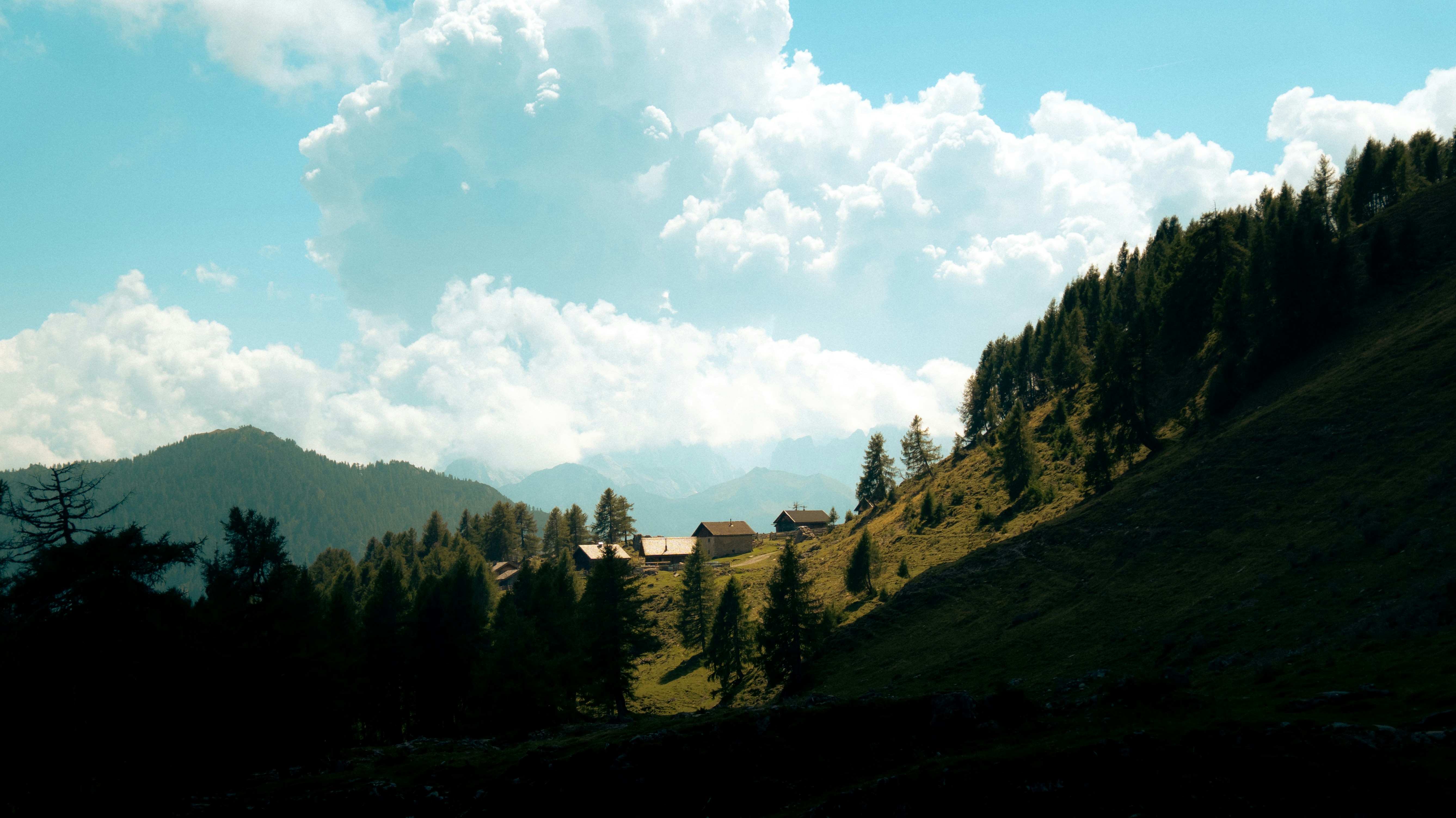 Sunny ridge: cottages resting on a hillside under a vast blue sky
