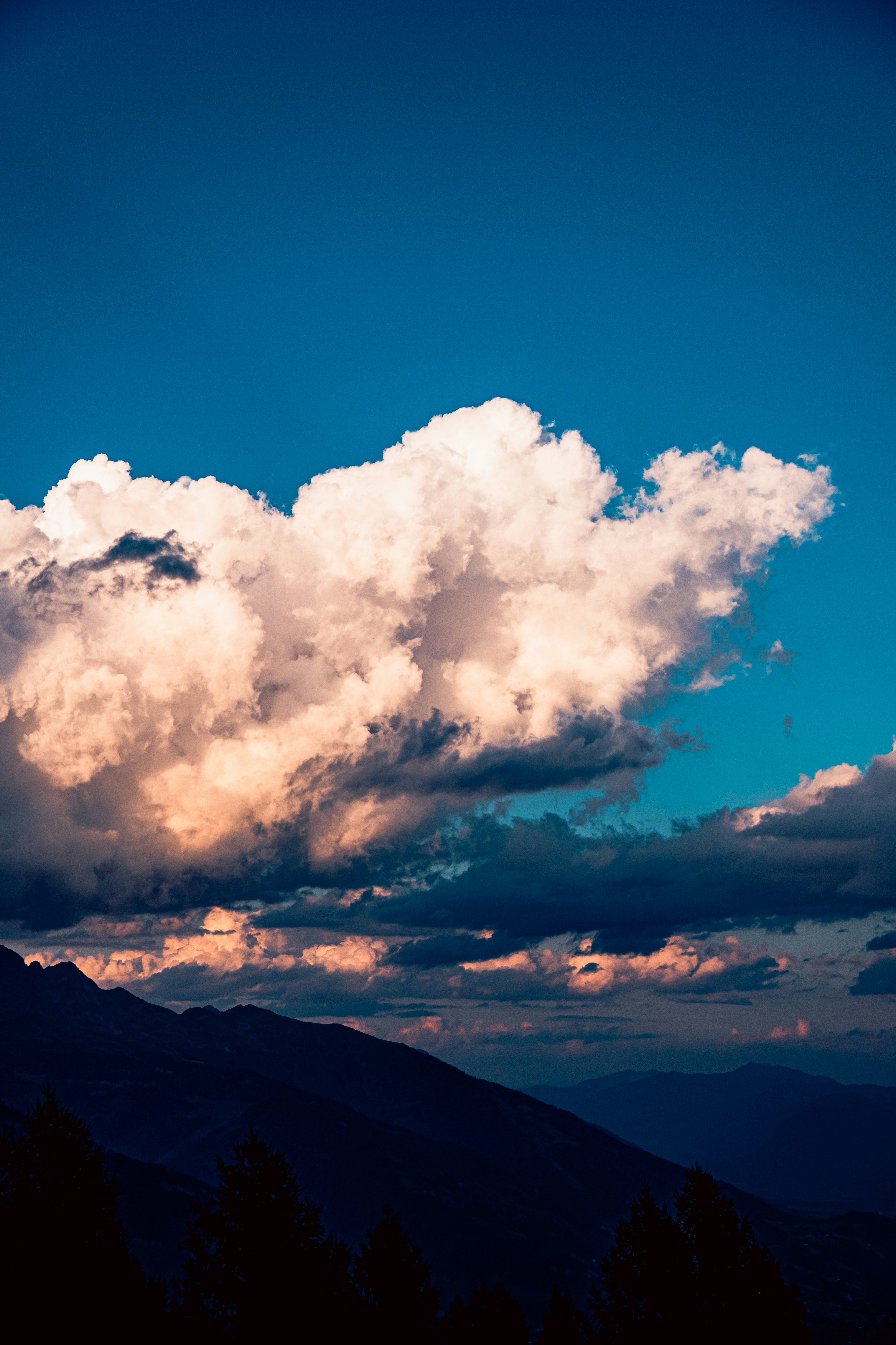 Majestic Cloud Burst Over Layered Mountain Range