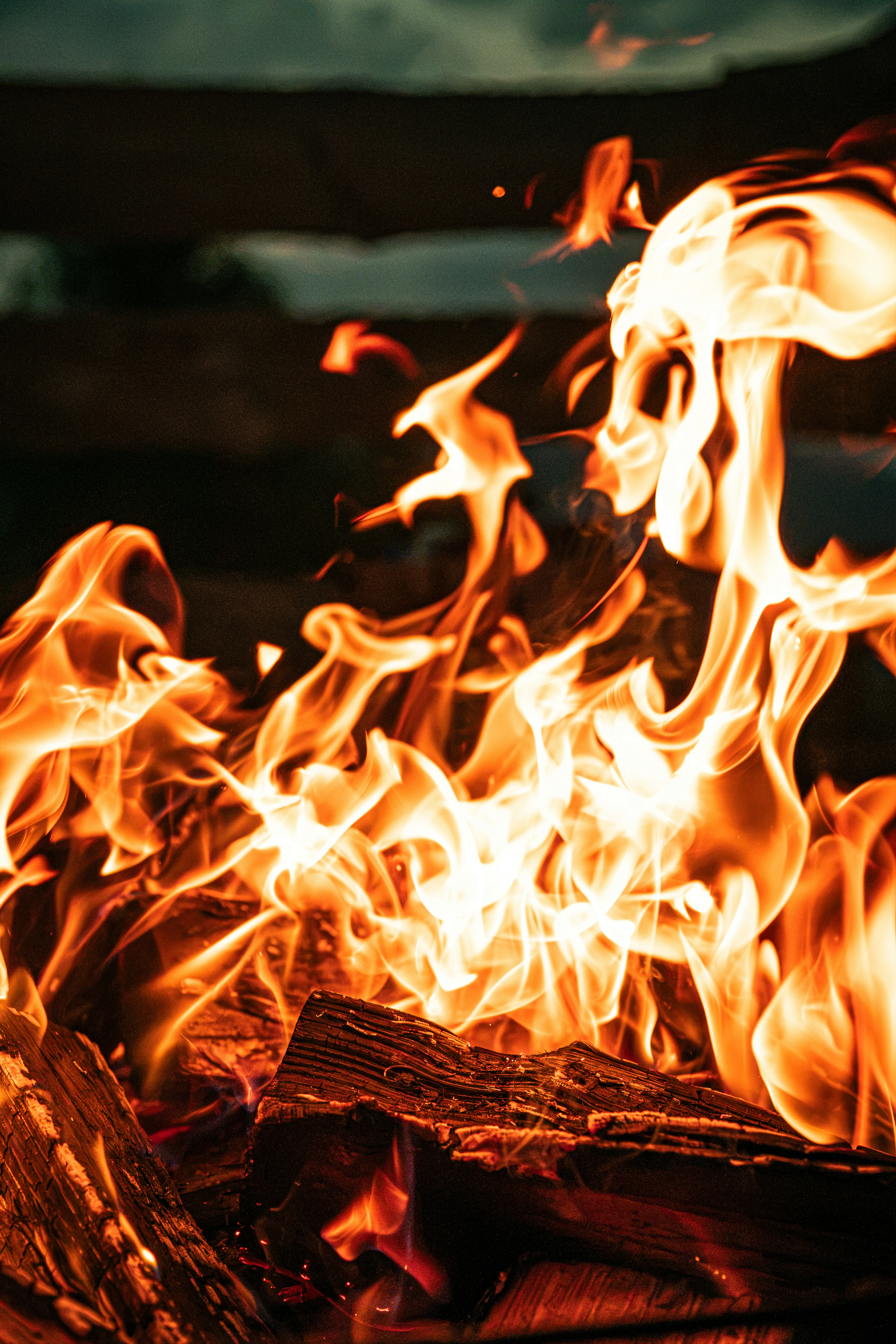 Flames in Focus: A Close-Up of Firelight and Charred Wood