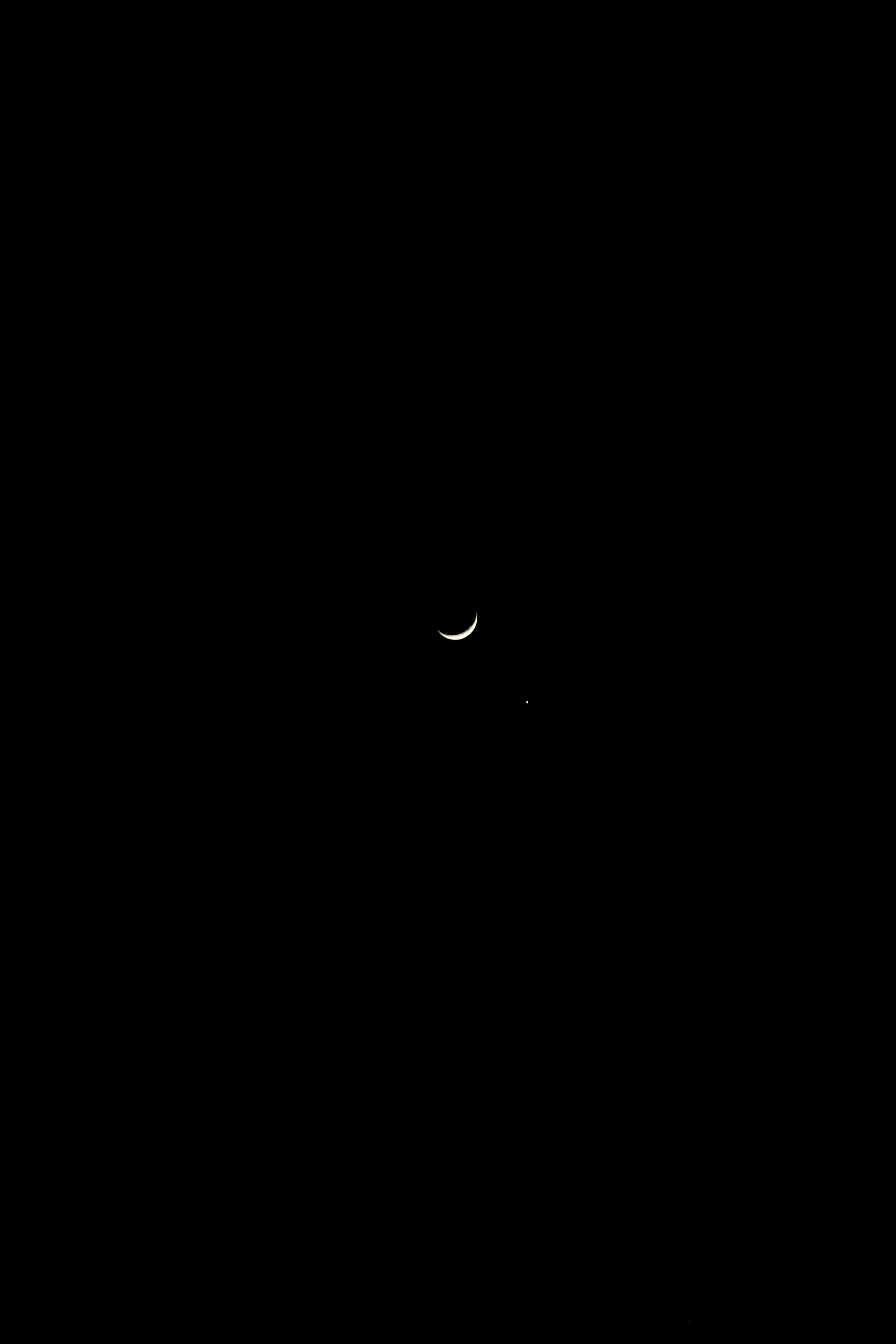 A Crescent Moon and Planetilluminated Night