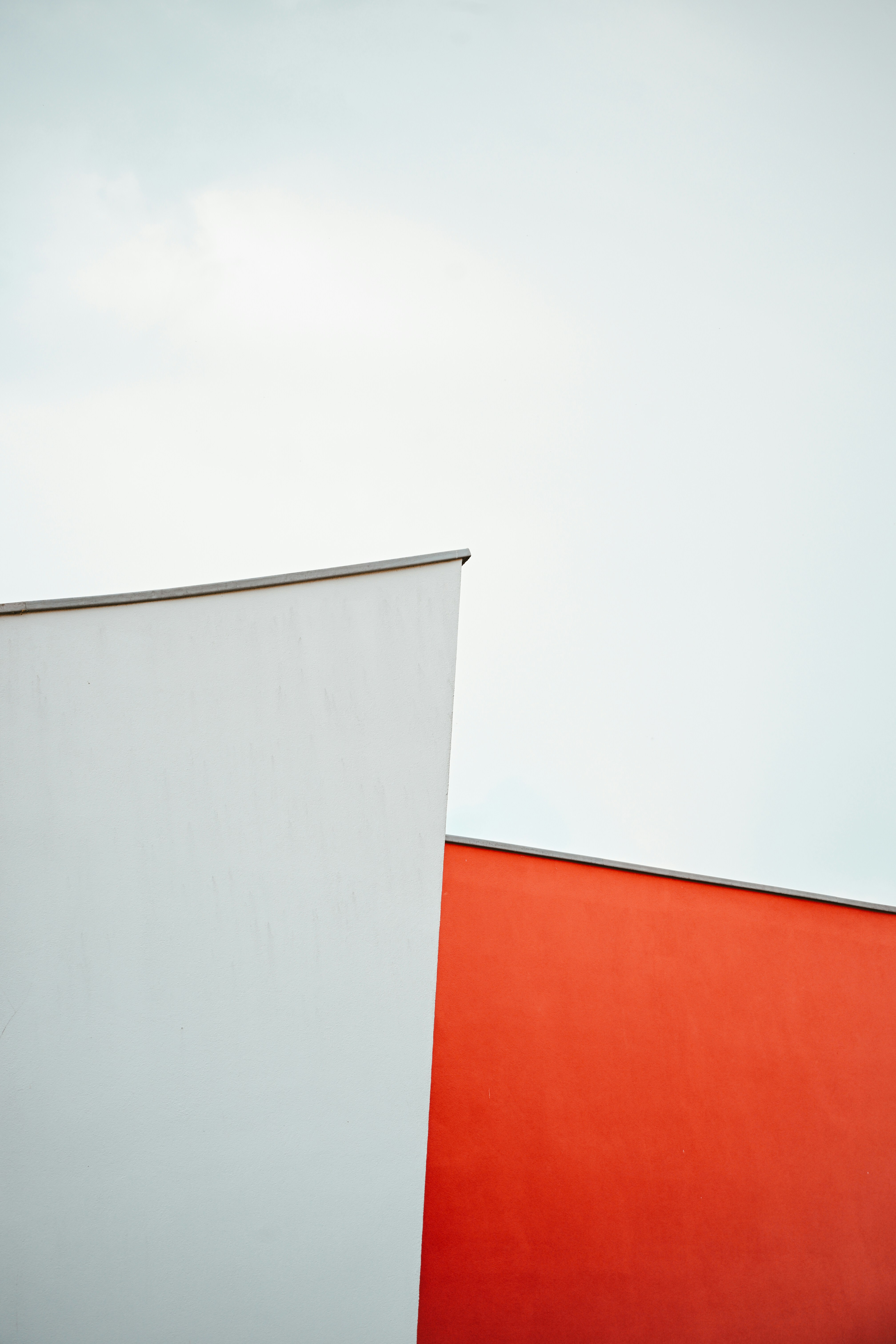 Angular Divide: White Facade Meeting Red Wall