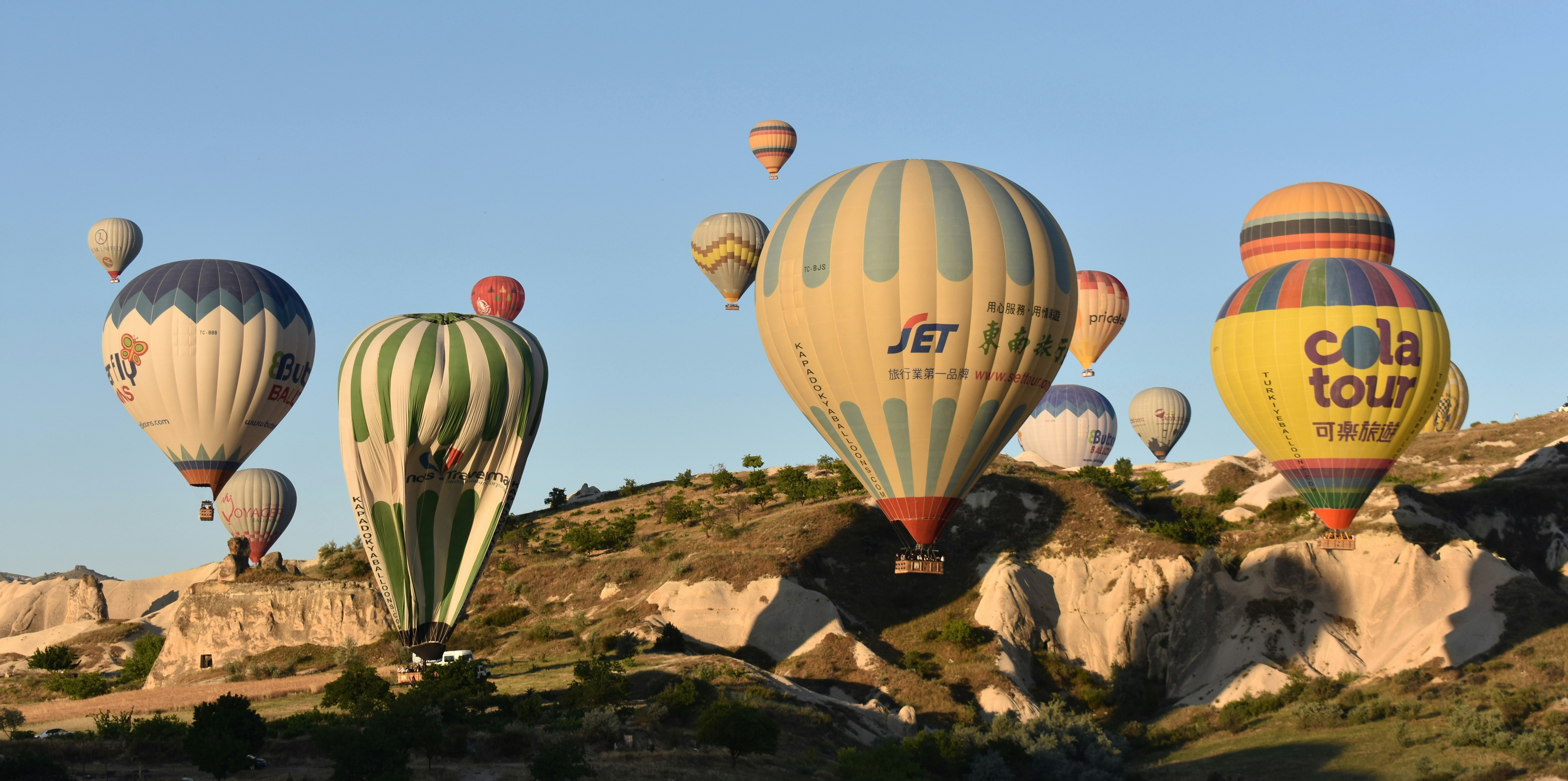 Balloon Chorus Over Desert Cliffs at Dawn