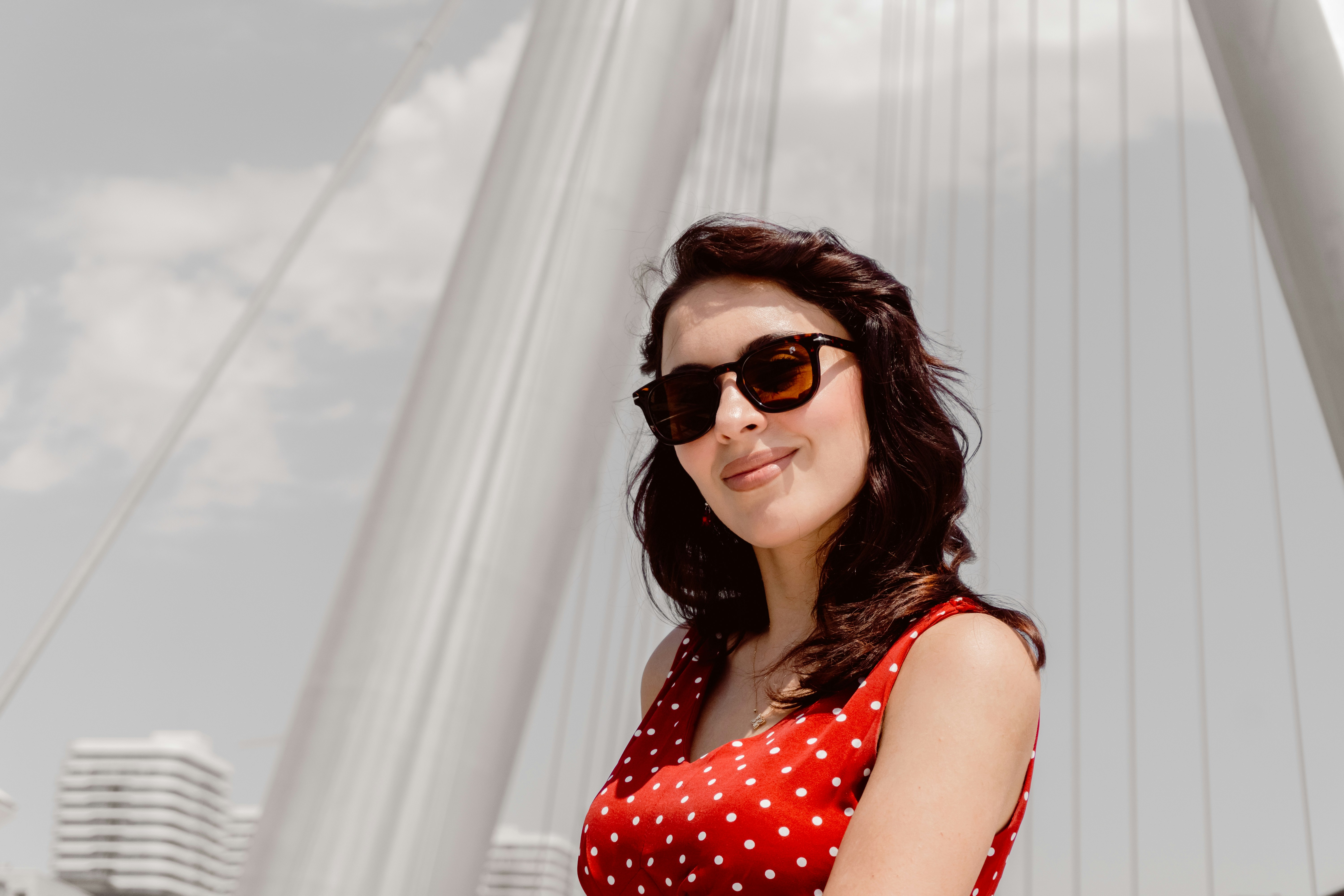 Polished Portrait in a Sunlit Urban Cable-Bridge Setting