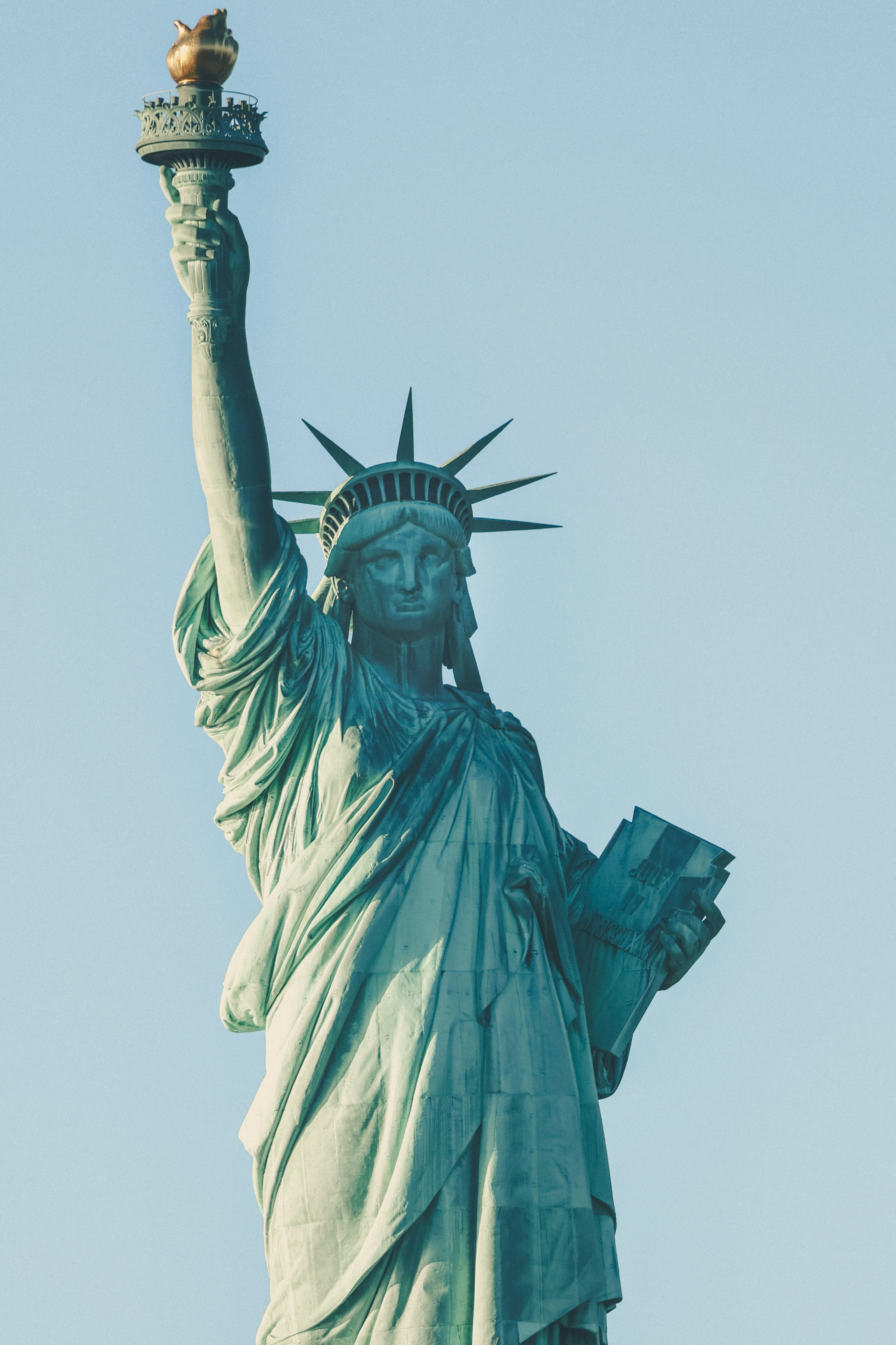 Emerald Torch: The Statue of Liberty Against a Clear Sky