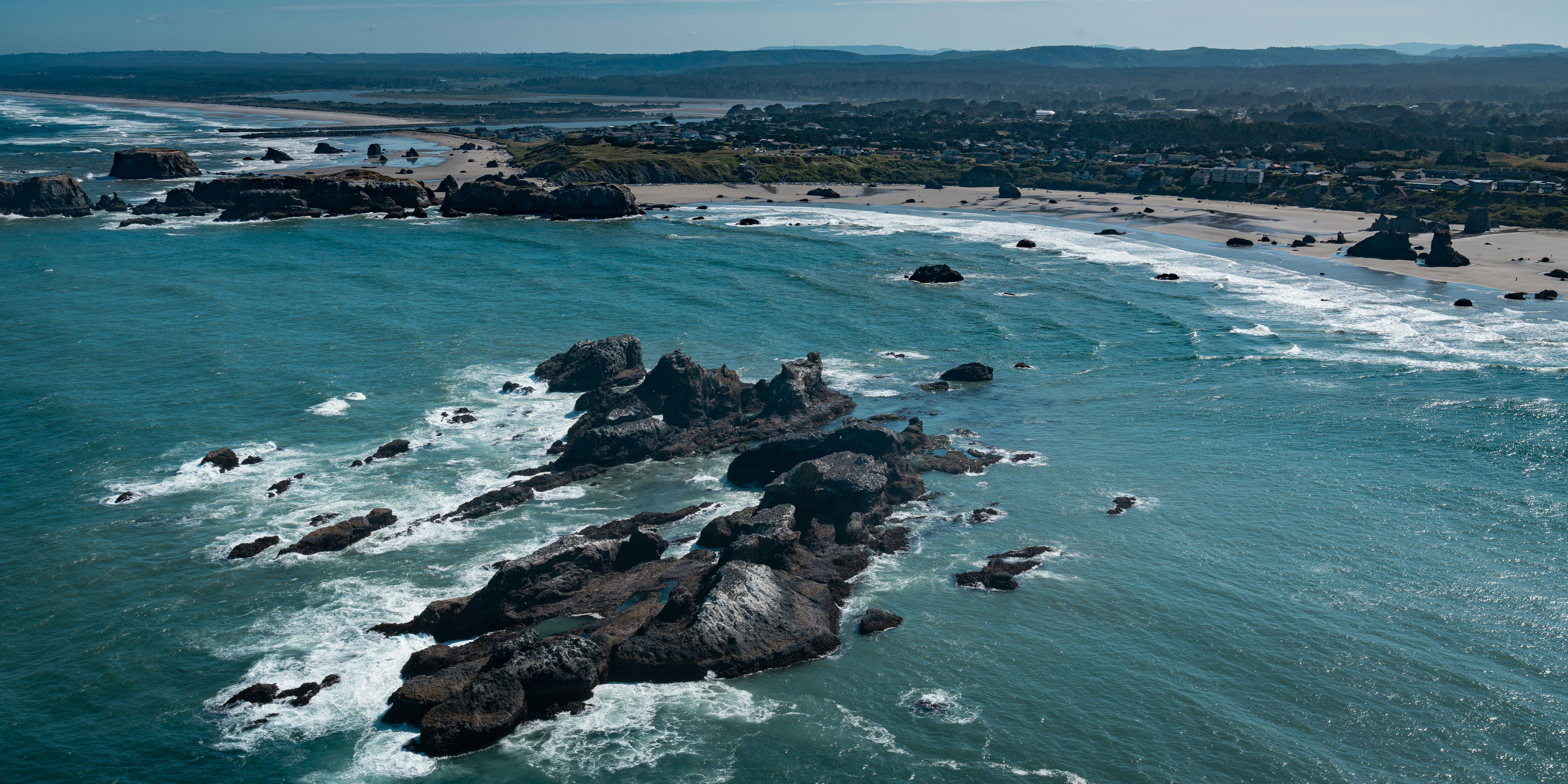 Rocky Breakers: A Crashing Coastline Under Blue Skies