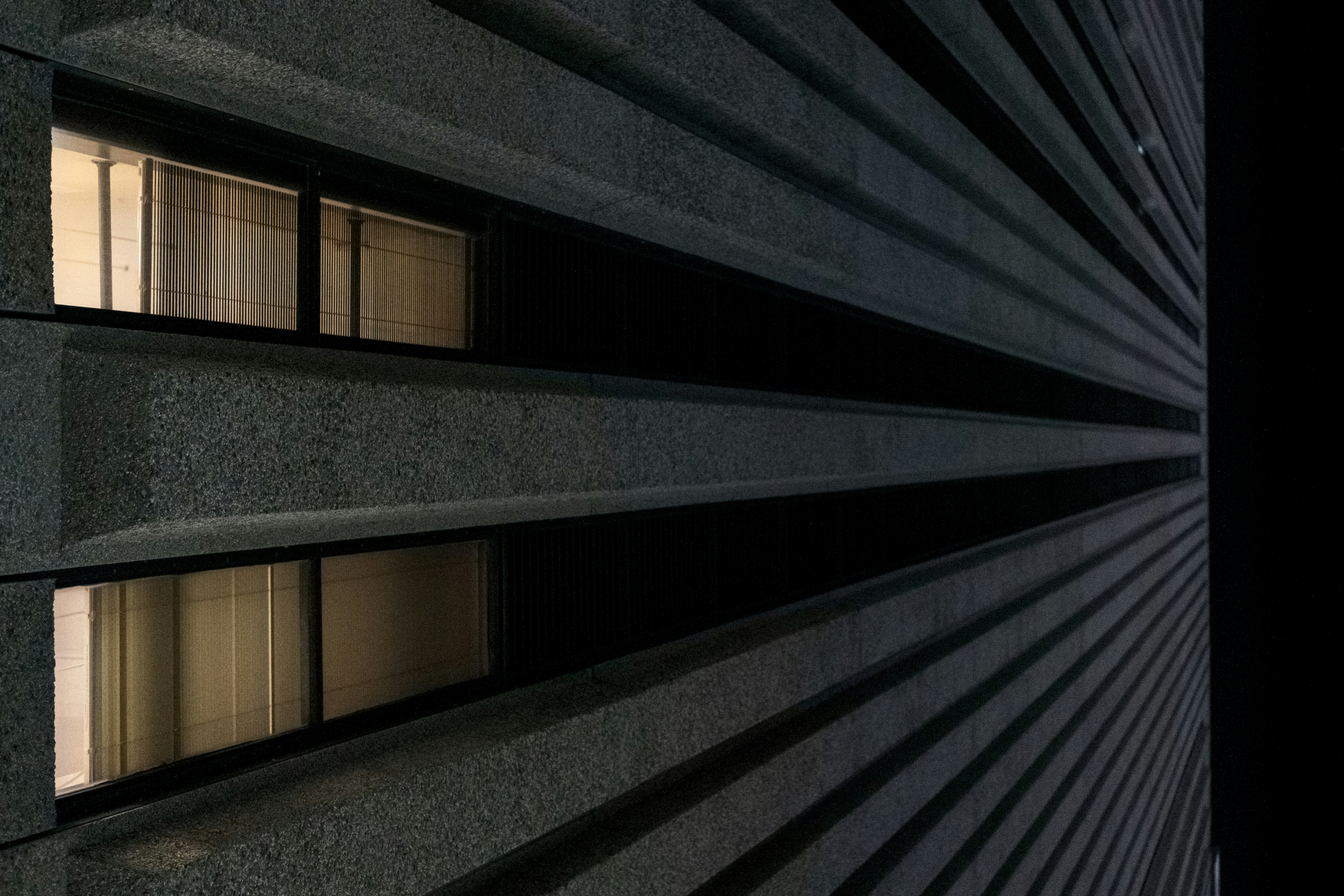 Hidden Windows, Quiet Facade: Night Lines of Concrete Strata