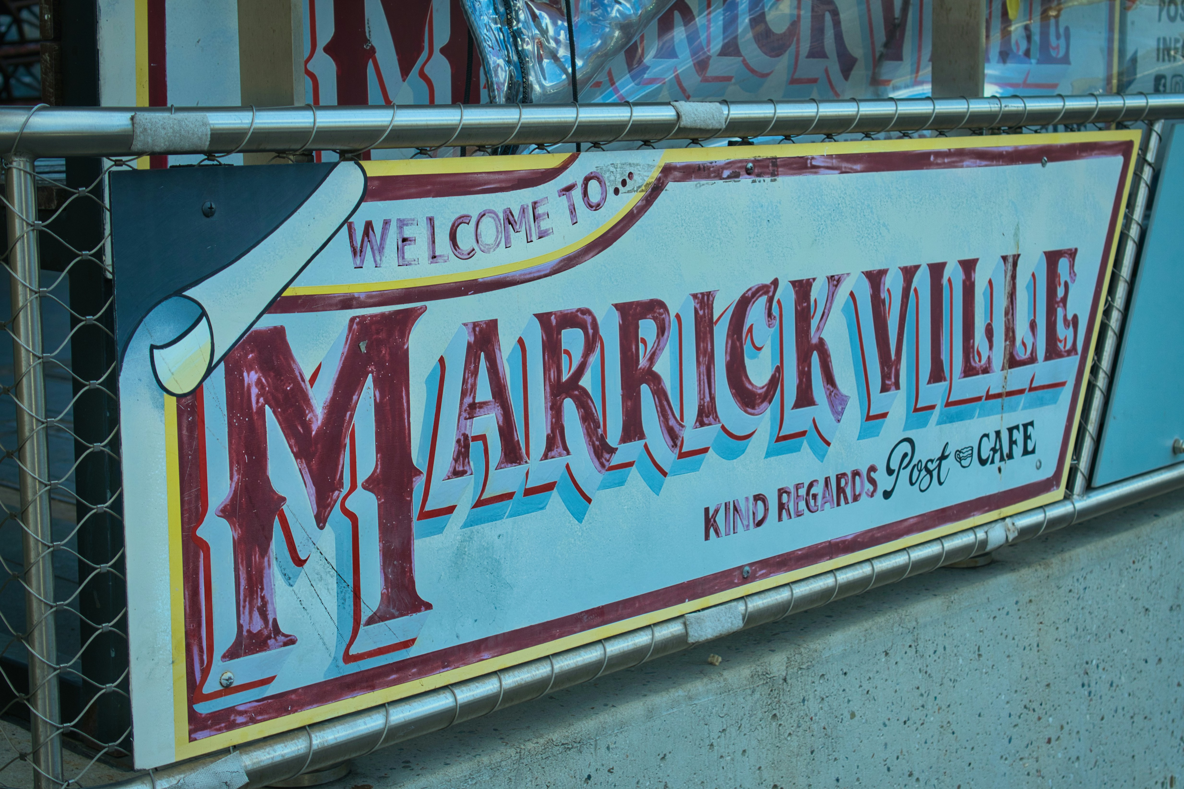 Marrickville Welcome Sign: Neon Blue Banner on Fence