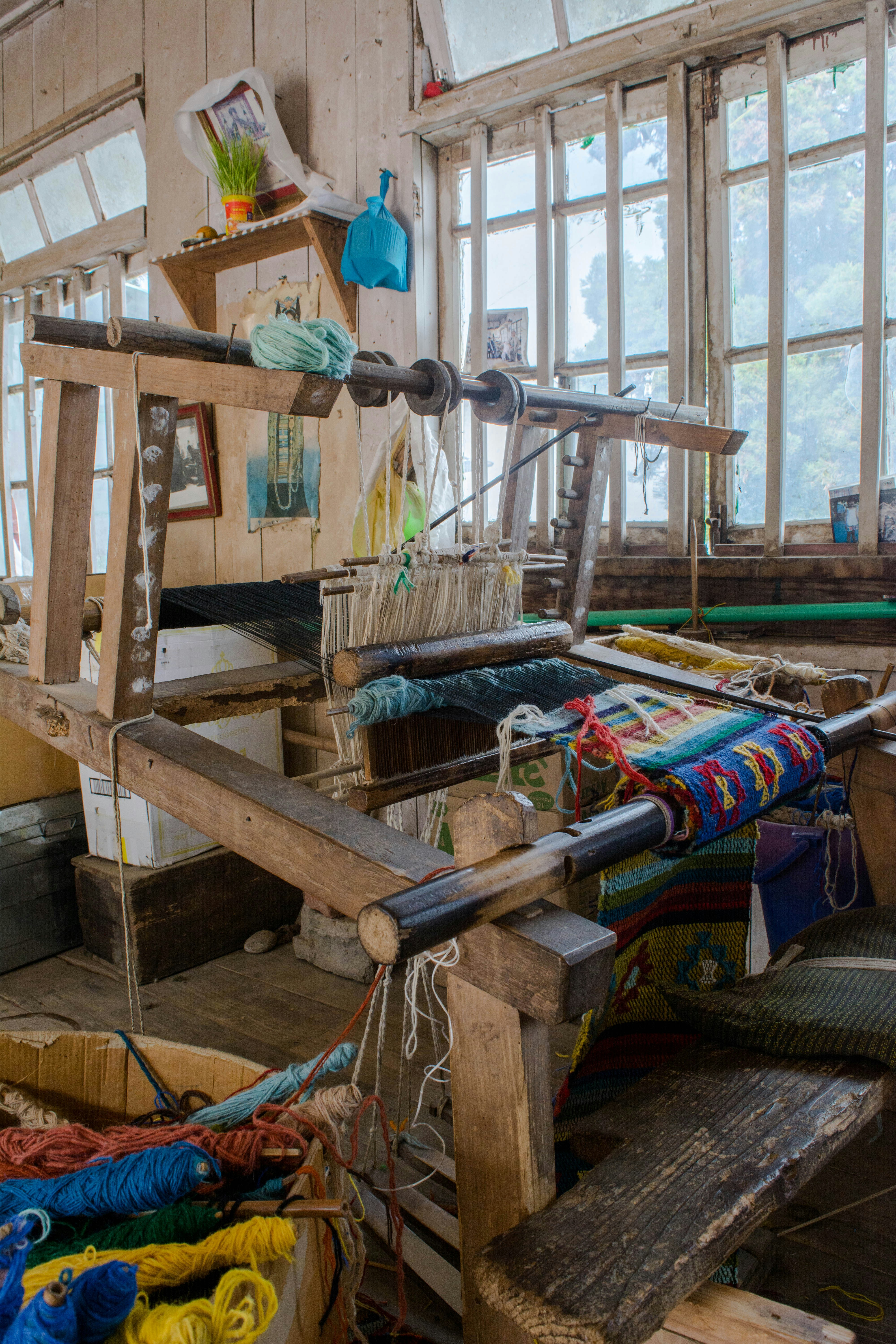 Traditional Loom Studio: A Century-Old Weaving Machine in Sunlit Workshop