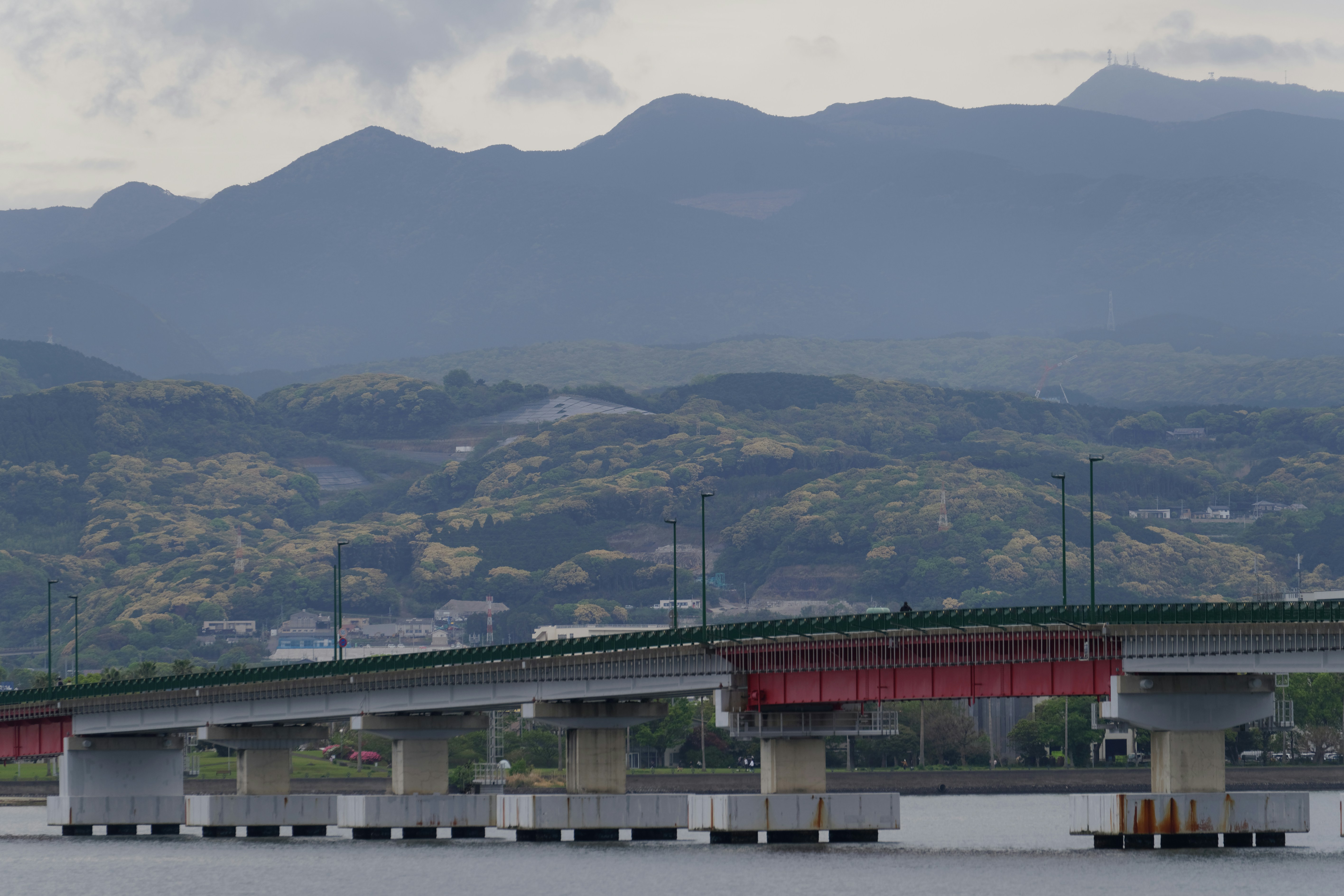 Bridge Over Calm Waters with Mountain Backdrop