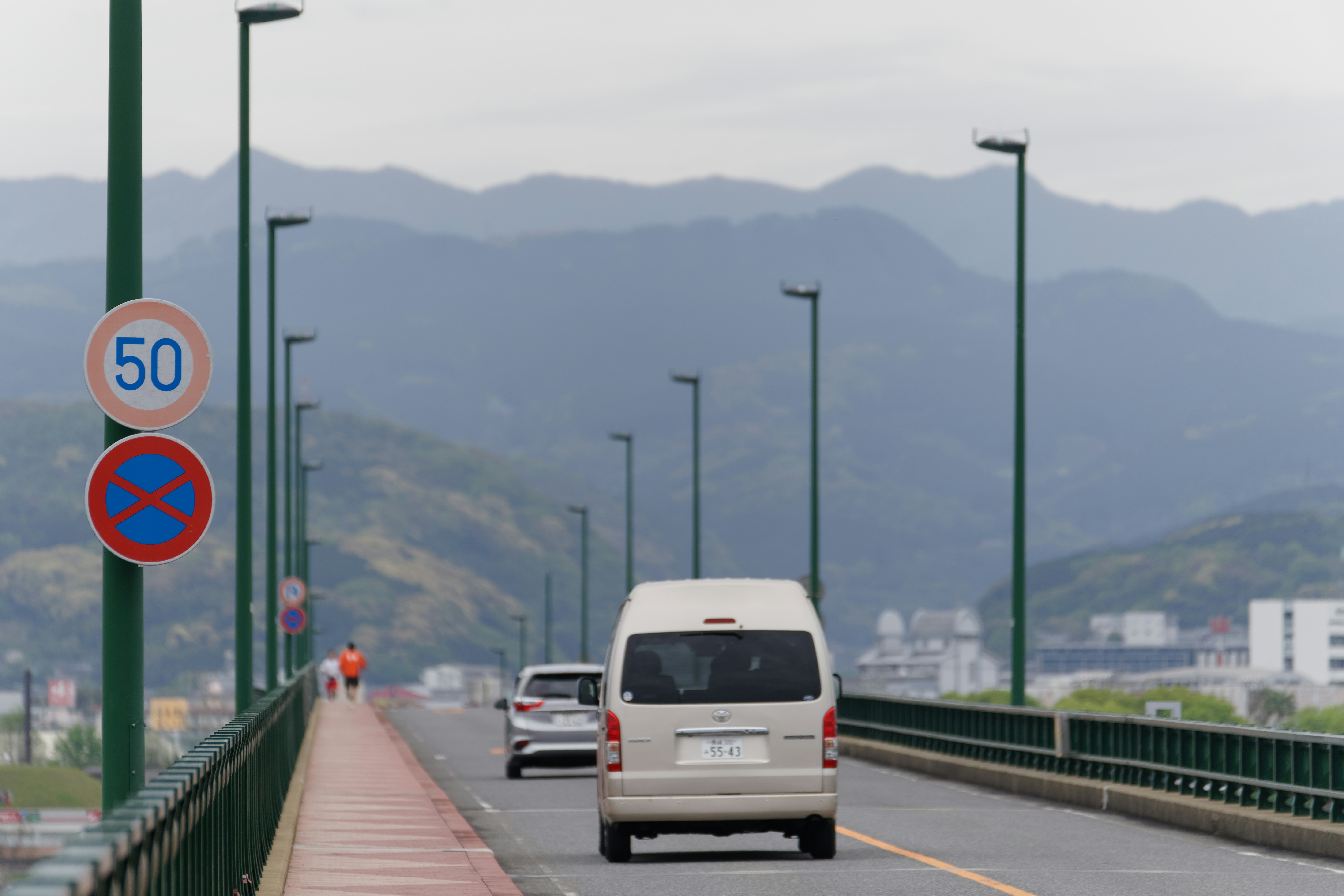 Road to the Mountain Horizon: A Quiet Transit Through a Coastal Bridge