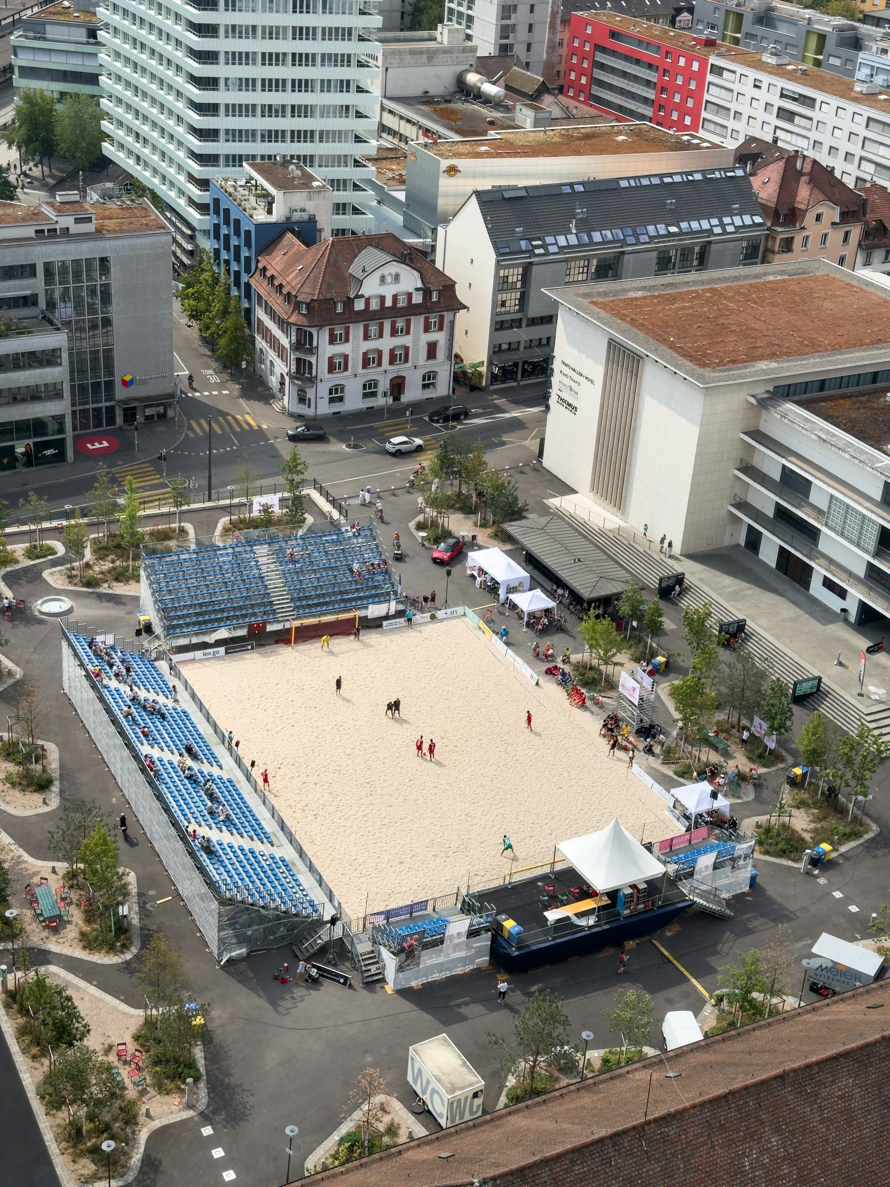 Aerial View of Urban Beach Volleyball Court Amid Cityscape