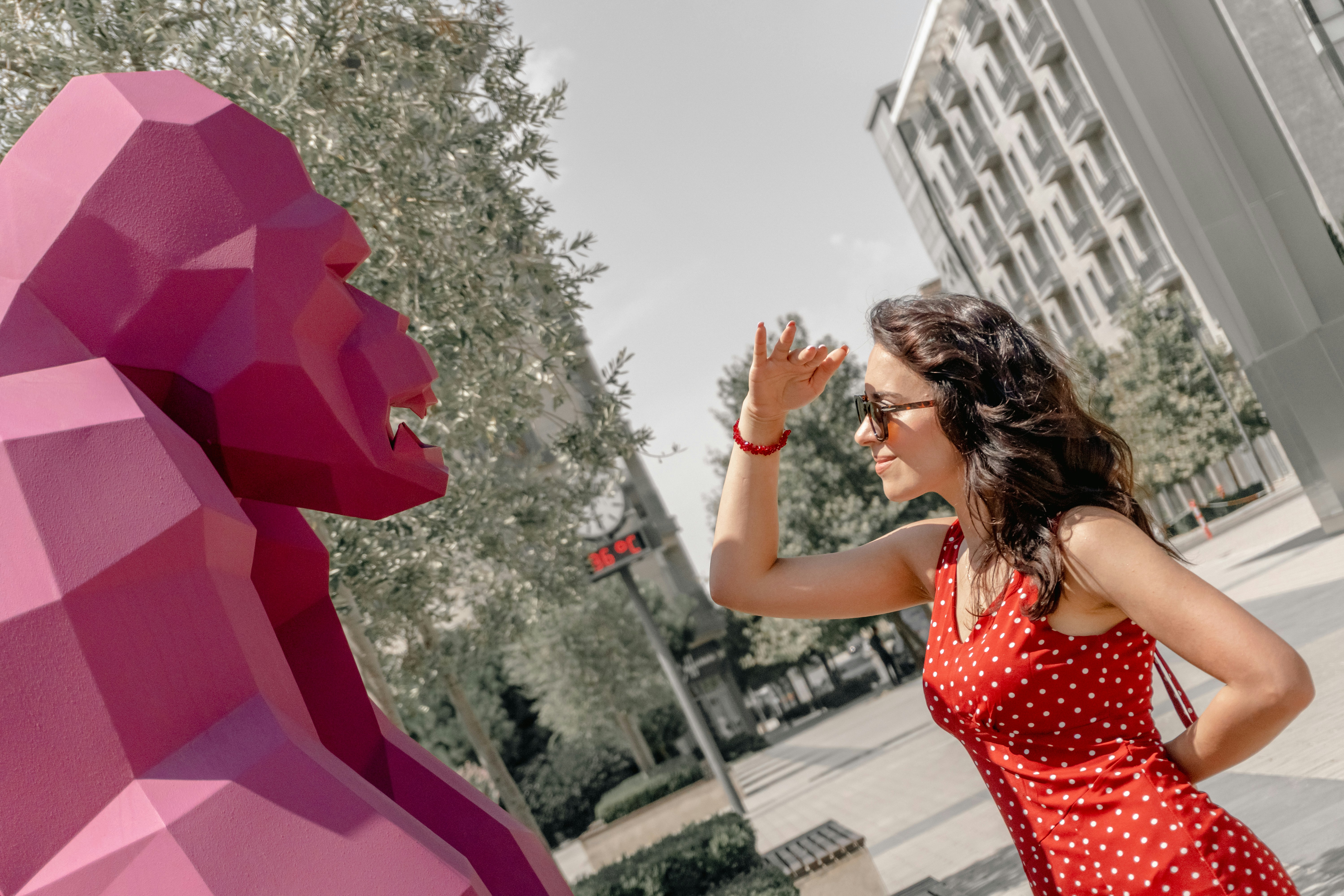 Red Polka-Dot Sunset Chase: A Woman and the Geometric Ape