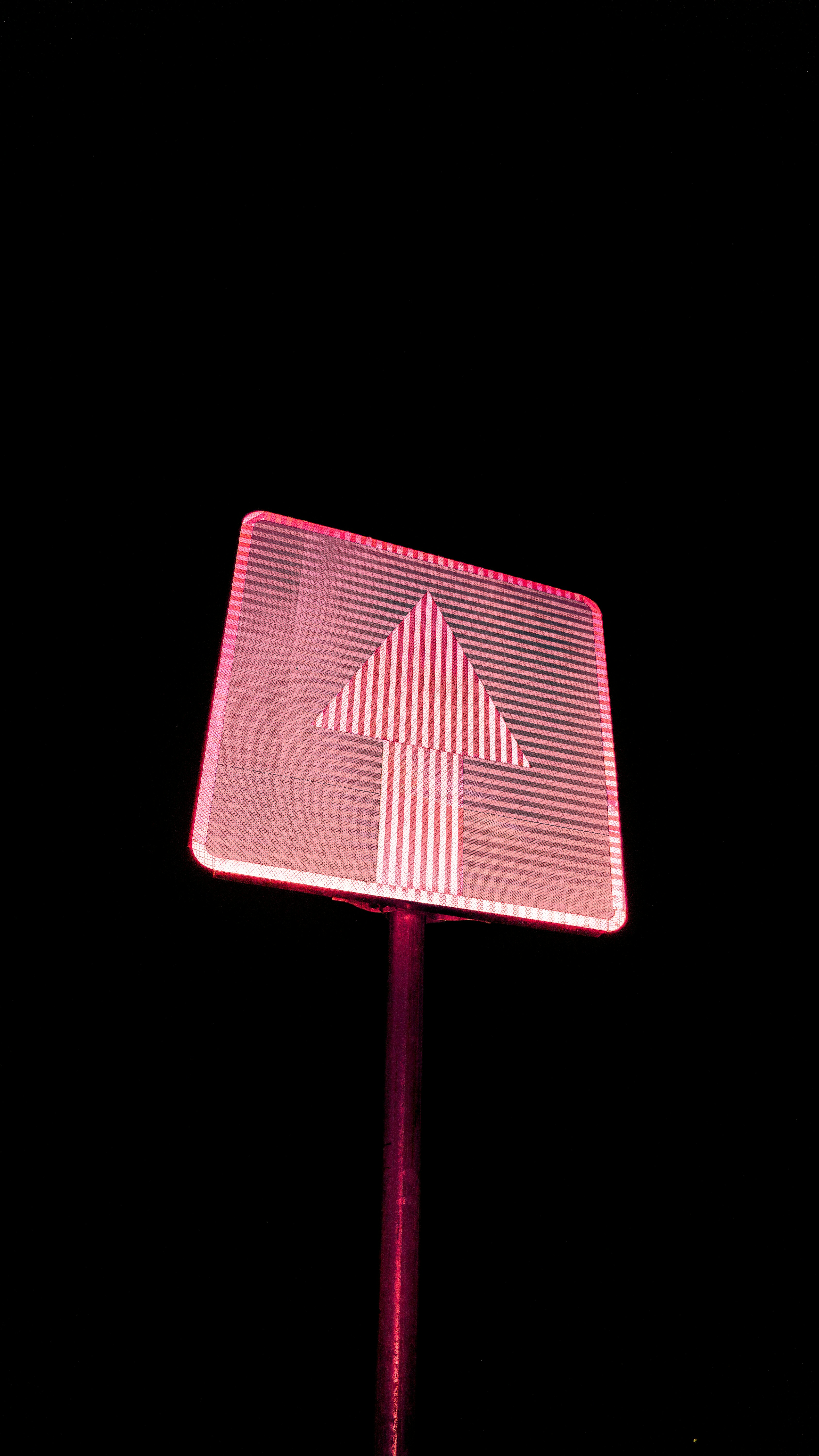 Neon Arrow at Night: A Red Sign Pointing Upward