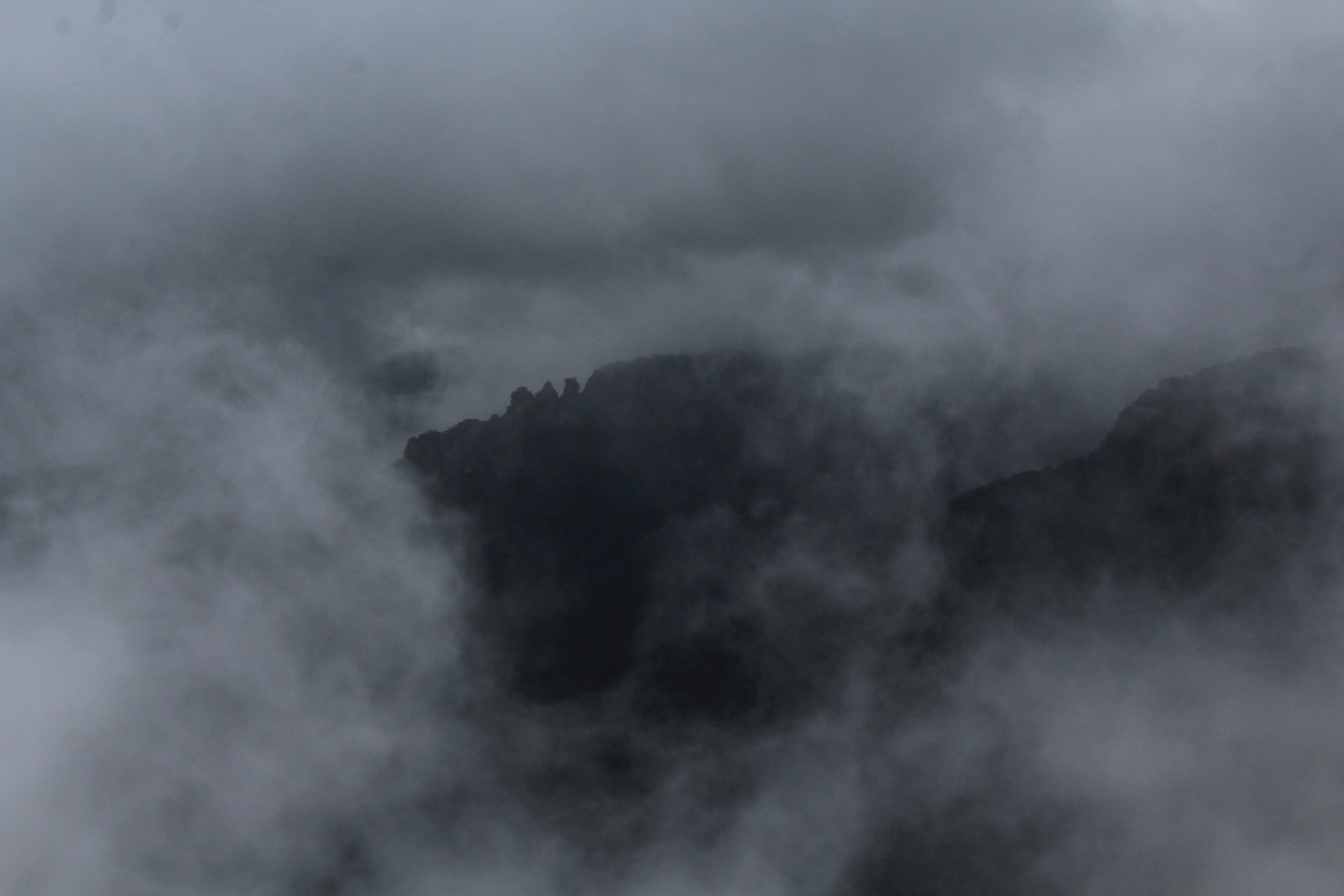 Mountains Rising Through a Veil of Clouds